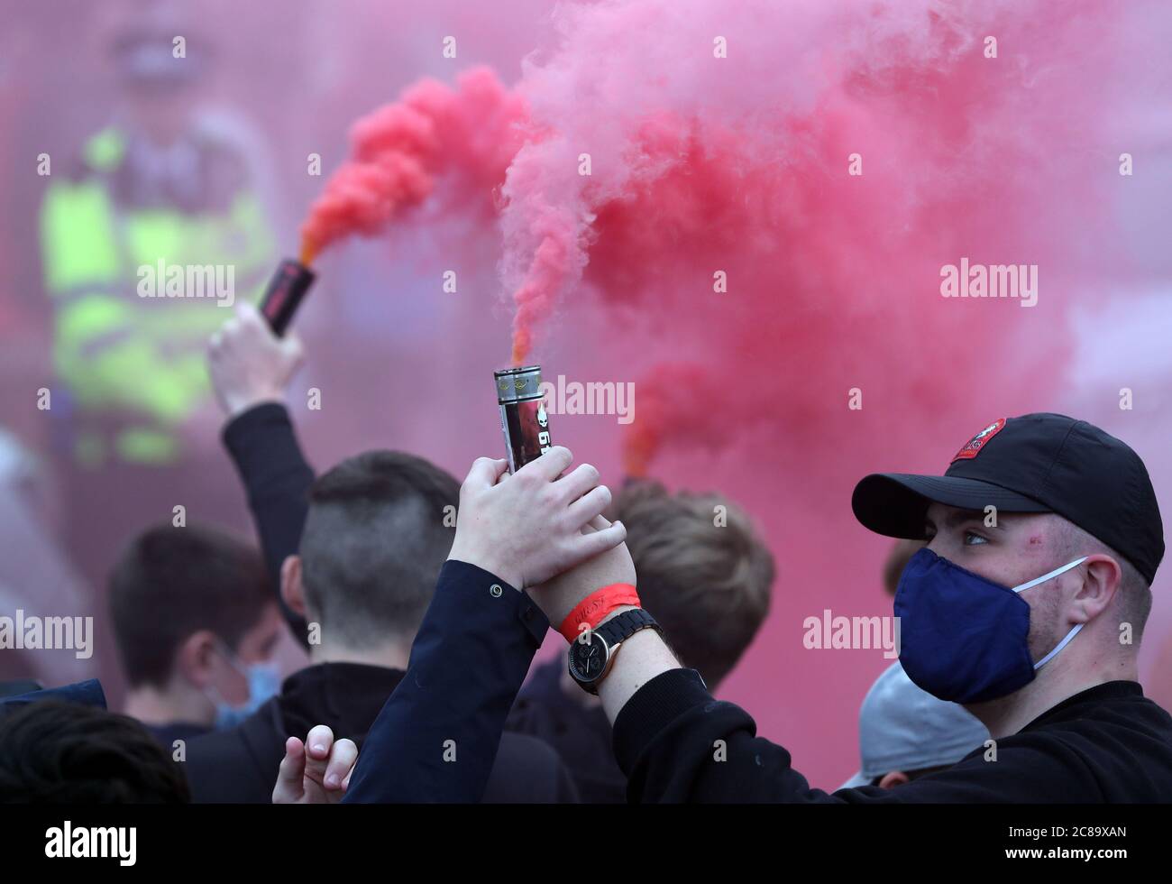 Liverpool fans set off flares outside Anfield as the Liverpool team bus ...