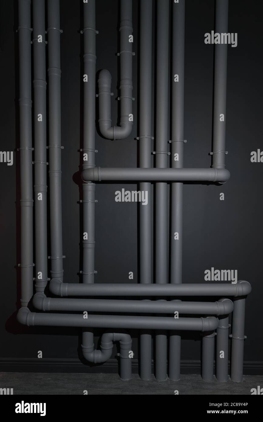Gray plastic drainage pipes system on wall Stock Photo - Alamy