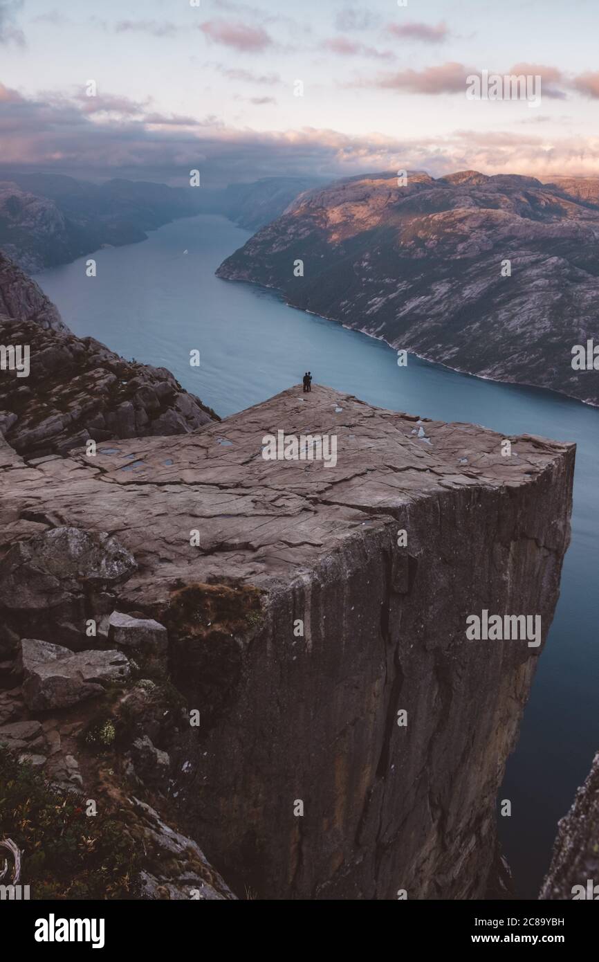 Unrecognizable man standing at cliff in Prekeistolen, Norway Stock ...