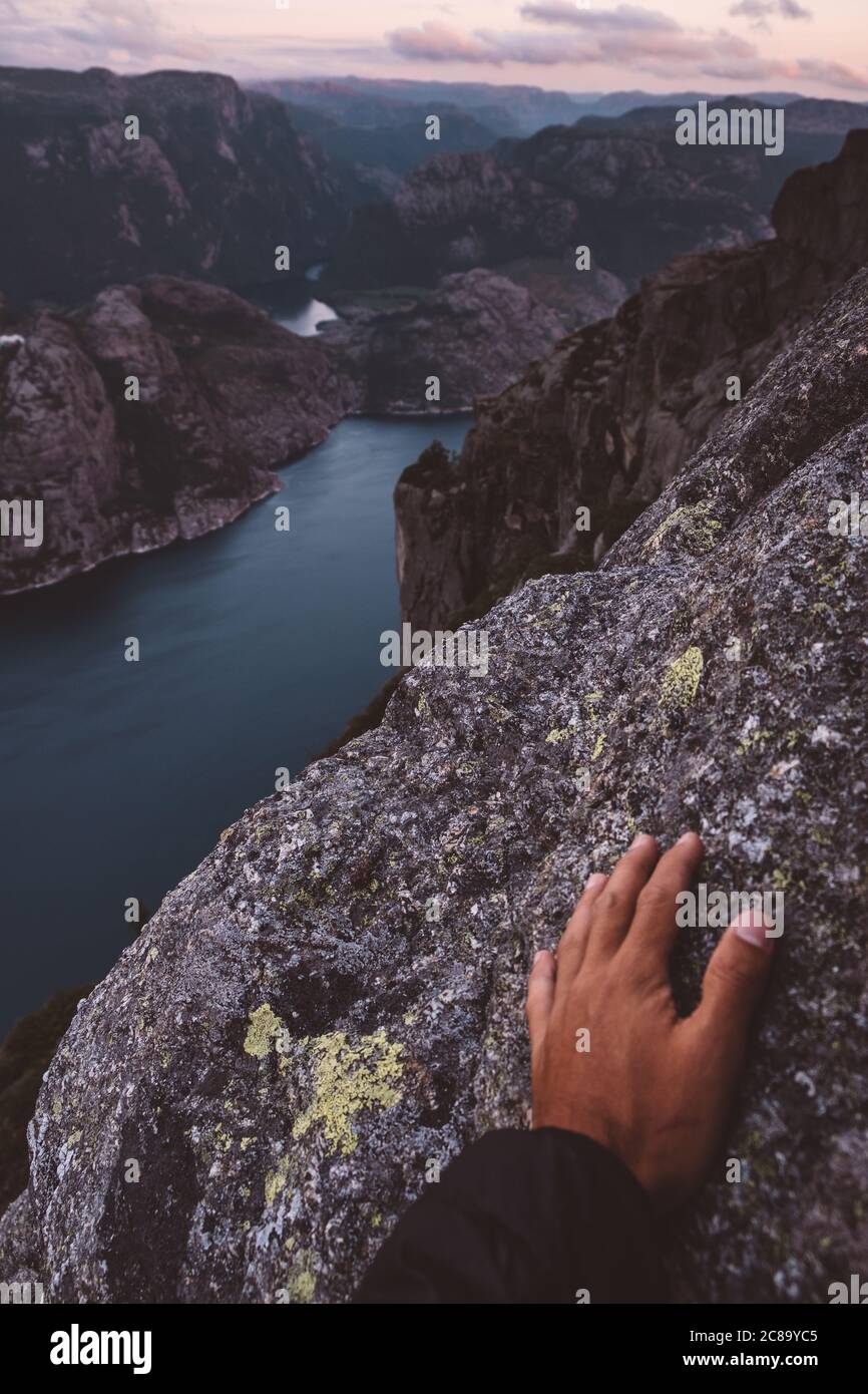 Hand on rock at Norwegian Fjords view on the background Stock Photo - Alamy