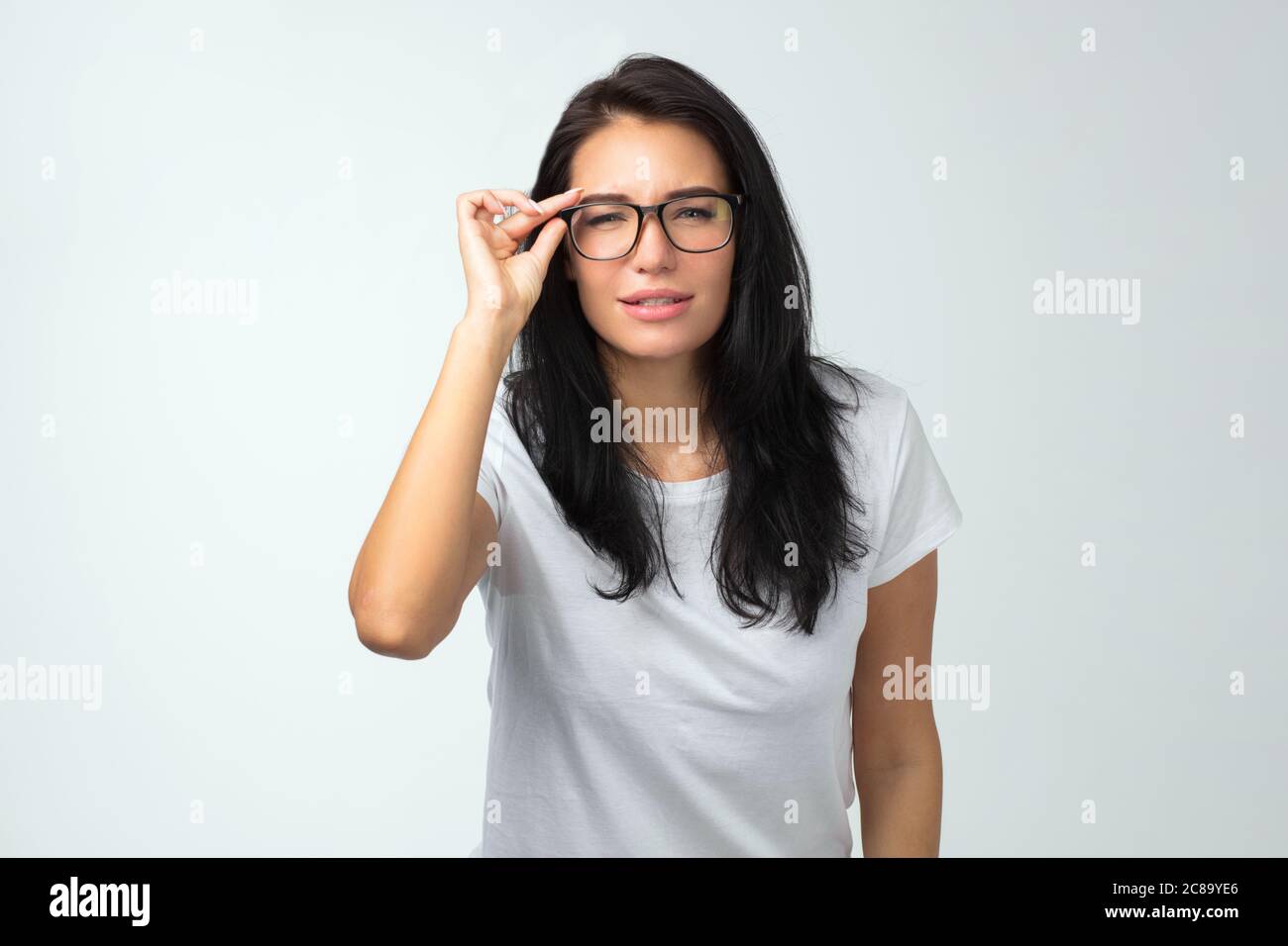 awessome girl with bad eyesight. female with suspicious look. problems ...