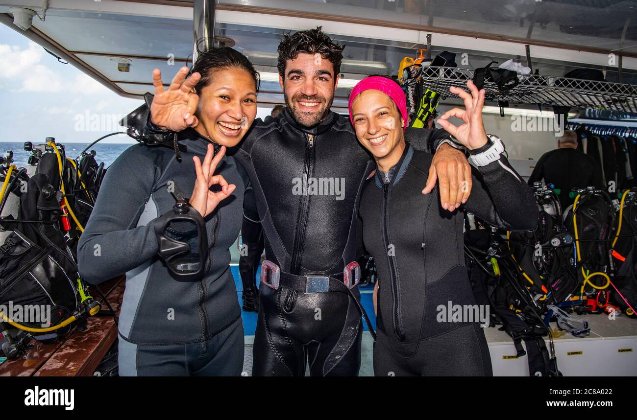 friends posing on the dive deck of exploration vessel Stock Photo - Alamy