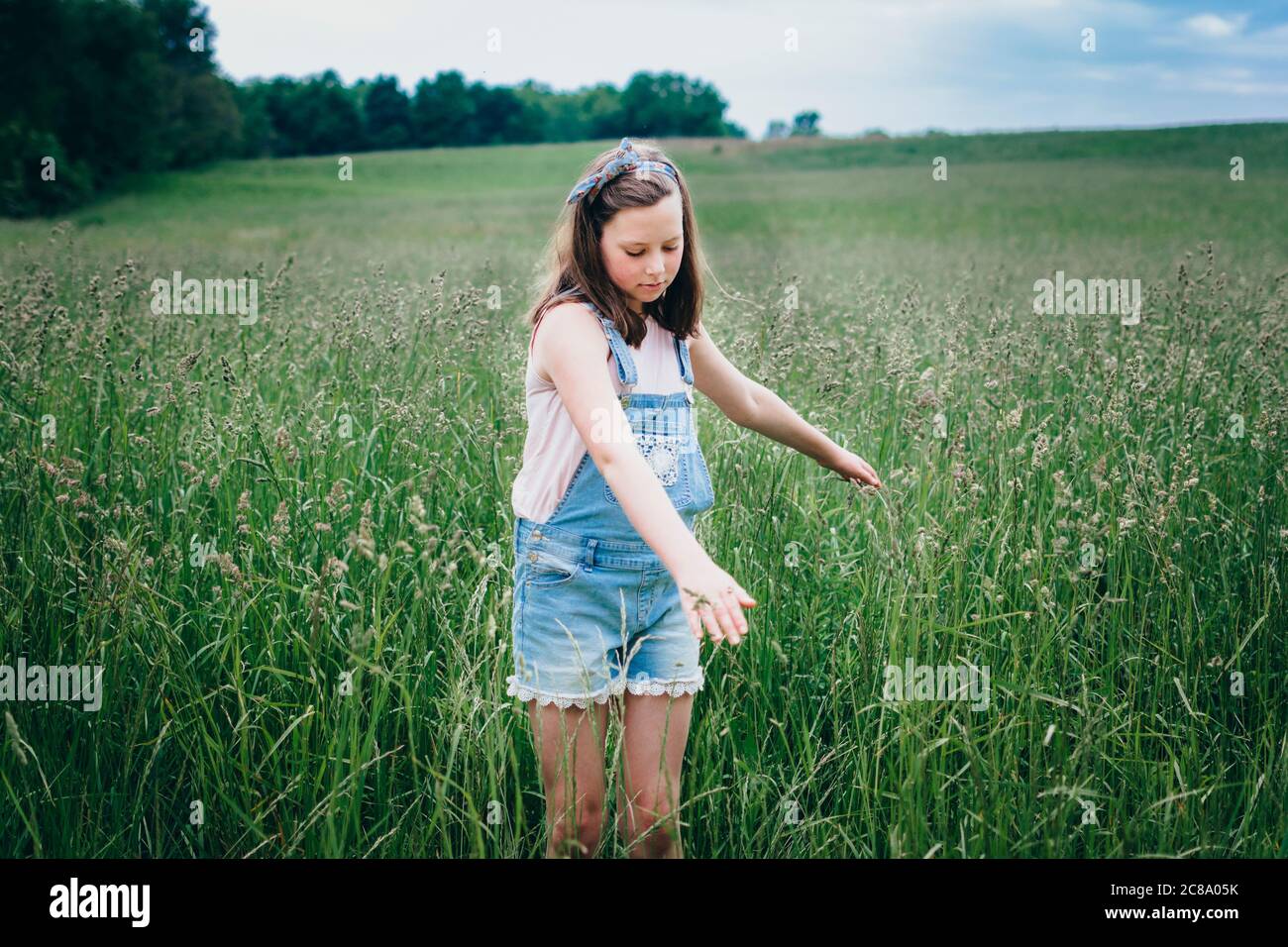 Girl running through tall grass hi-res stock photography and images - Alamy