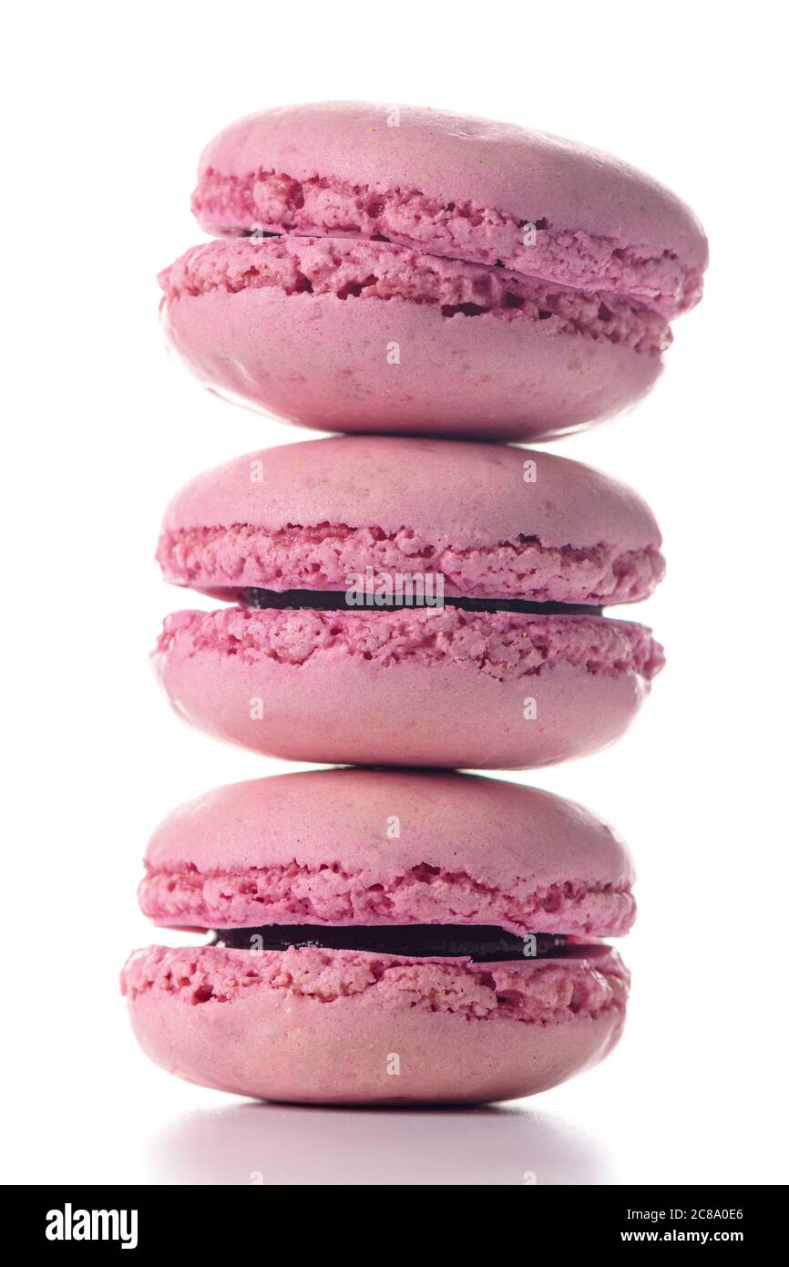 Three raspberry flavoured macaroons standing on top of each other on ...