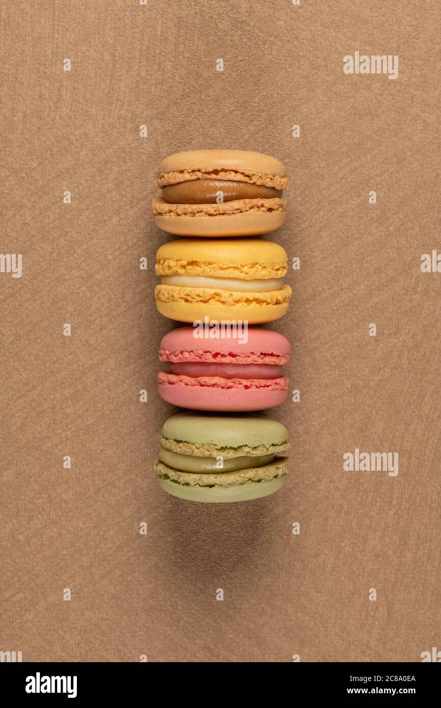 Four macaroonson brown vinyl background Stock Photo - Alamy