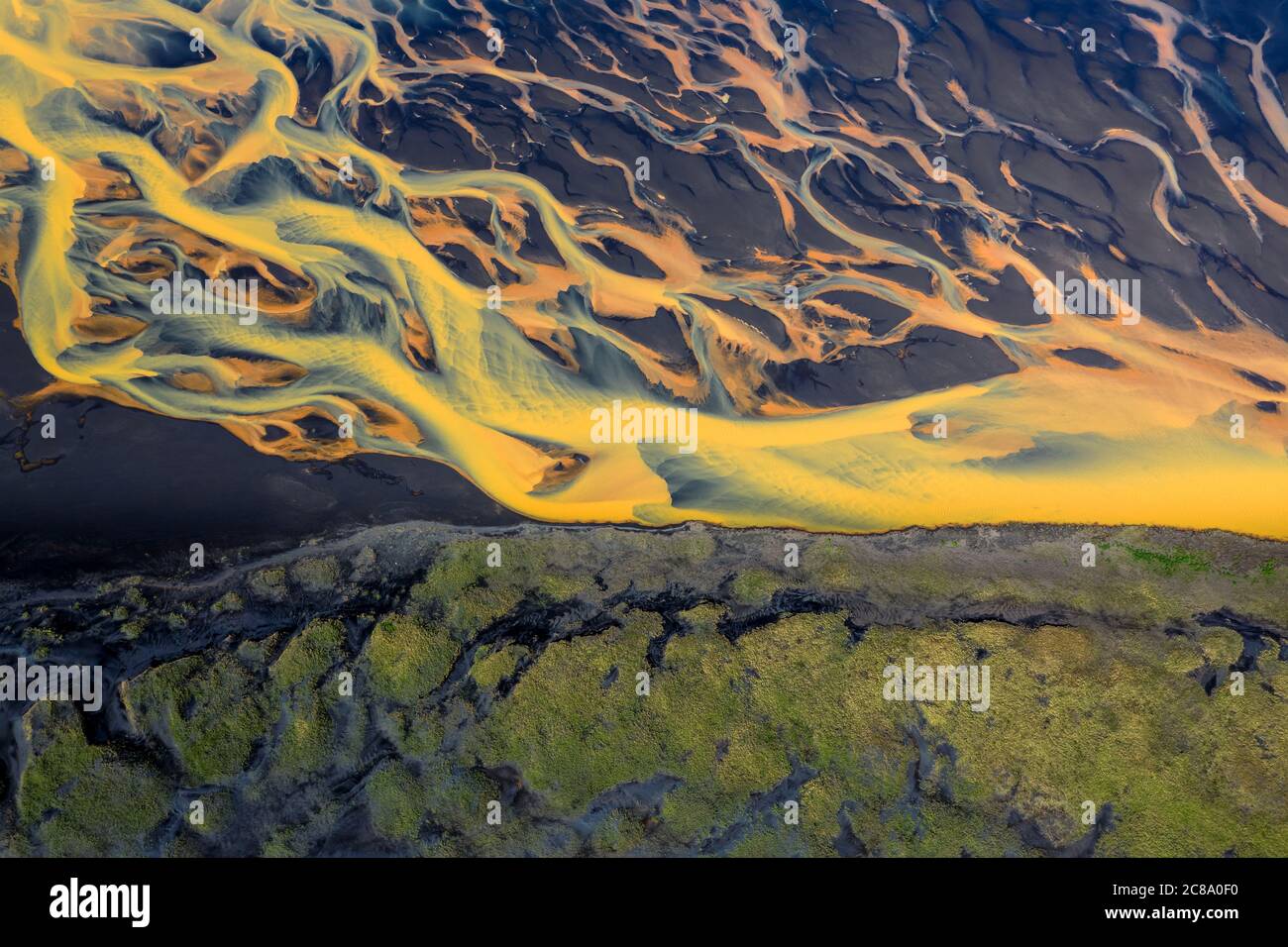 Colorful glacier rivers on the south coast of Iceland with black sand ...