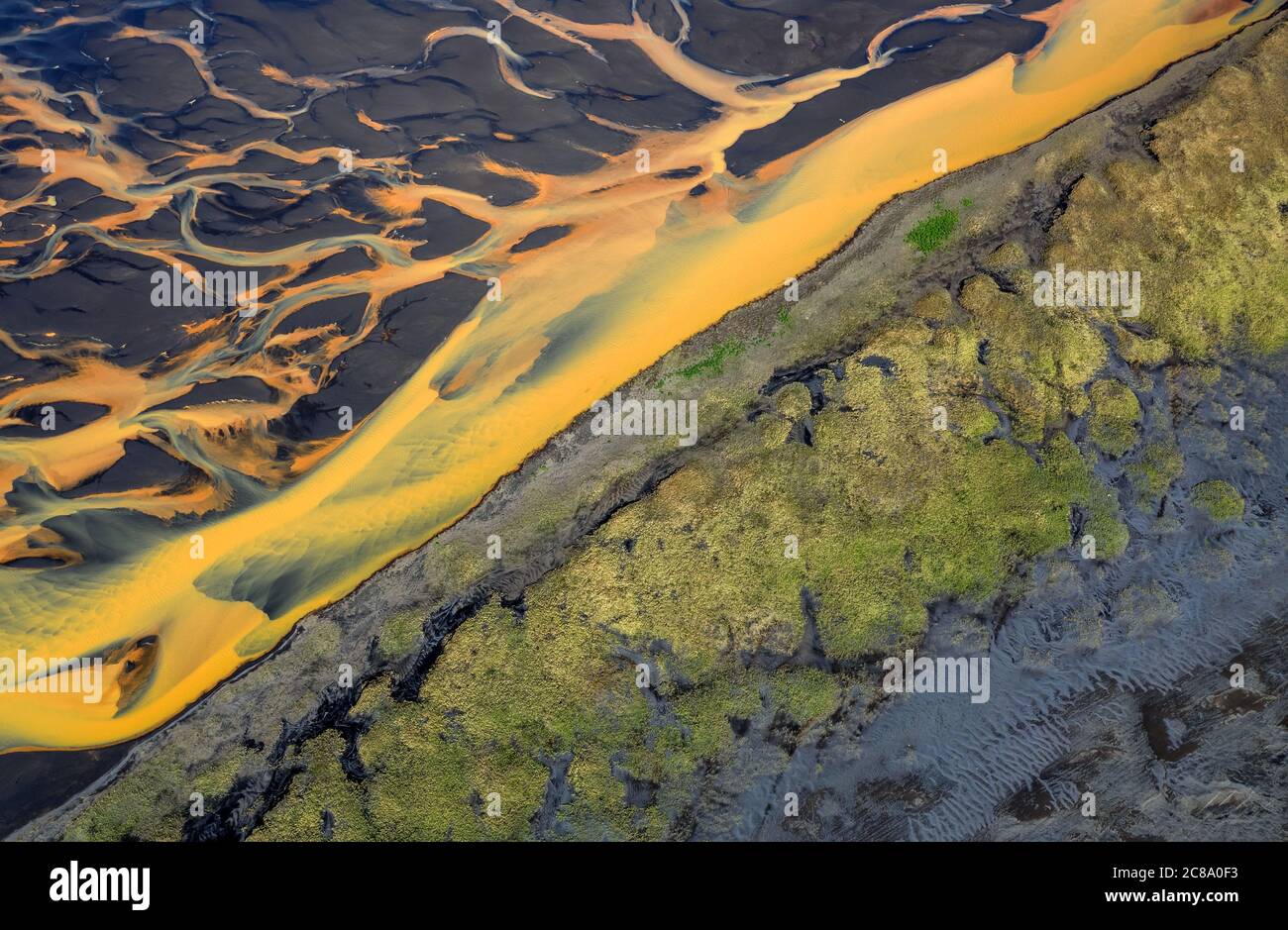 Colorful glacier rivers on the south coast of Iceland with black sand ...