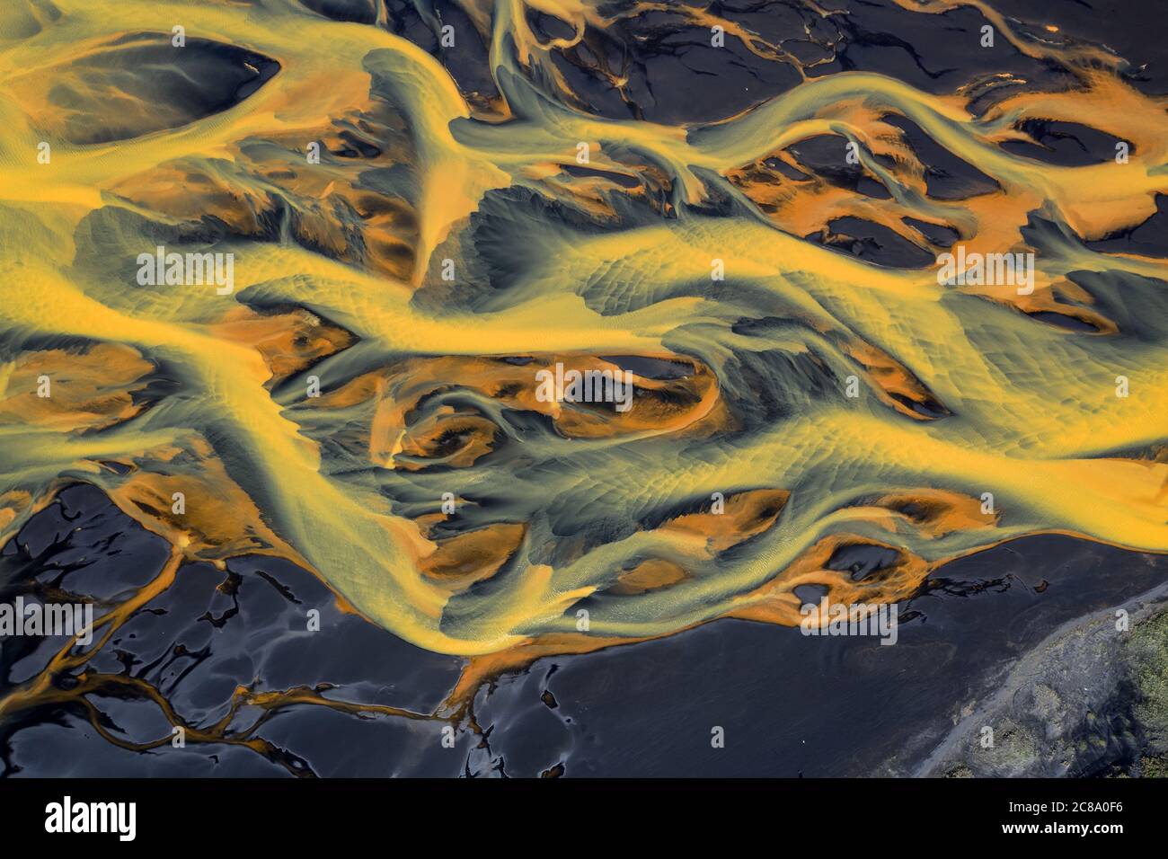 Colorful glacier rivers on the south coast of Iceland with black sand ...