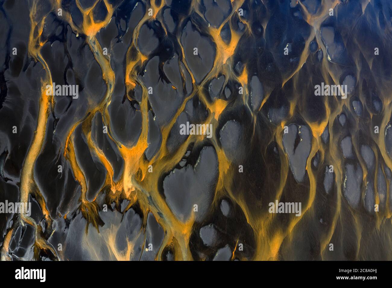 Colorful glacier rivers on the south coast of Iceland with black sand ...