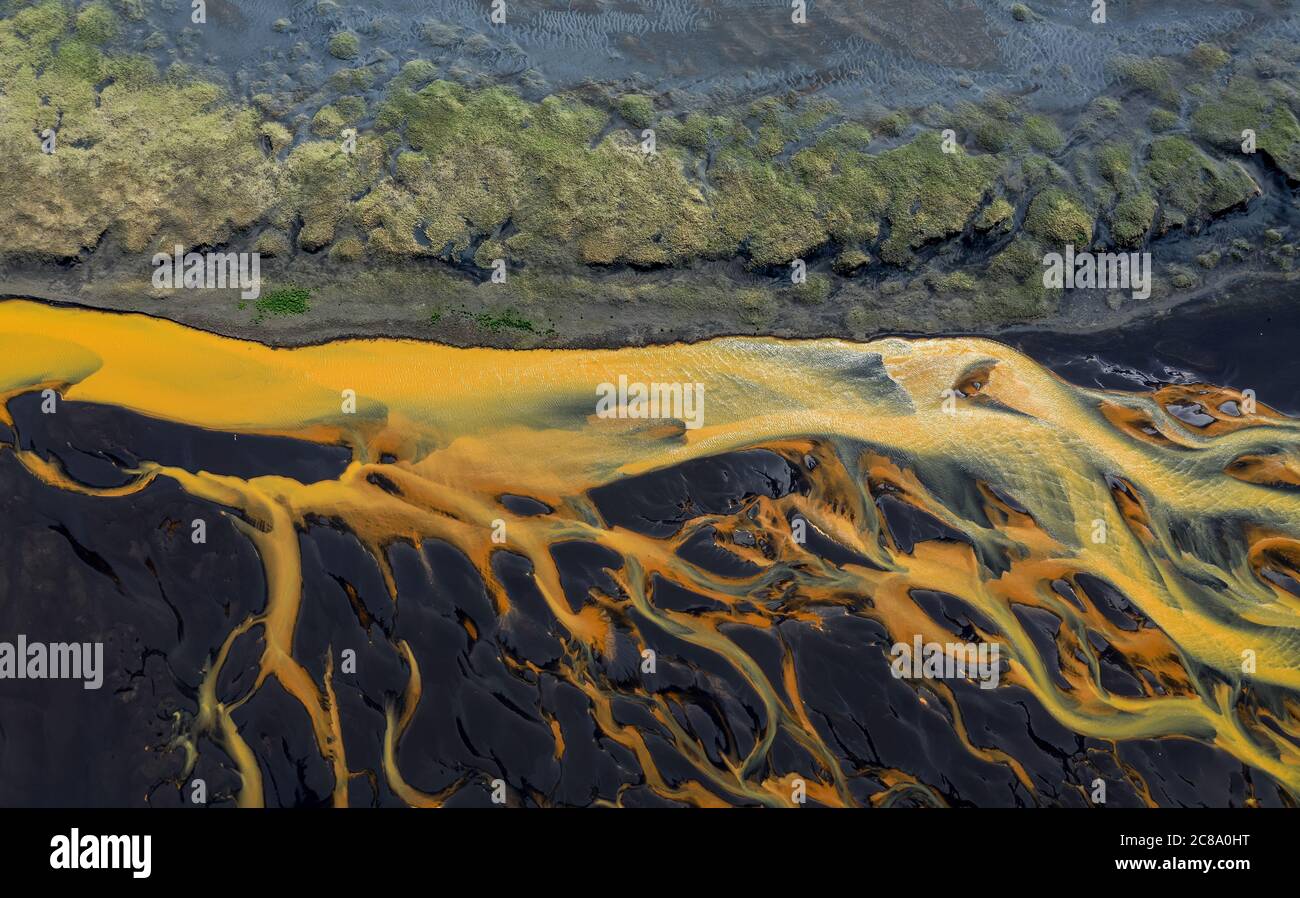 Colorful glacier rivers on the south coast of Iceland with black sand ...