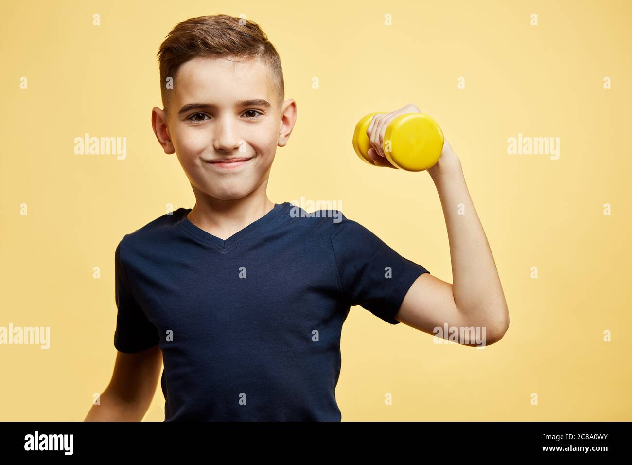 boy fitness lifts dumbbells. happy childhood, children sports Stock ...