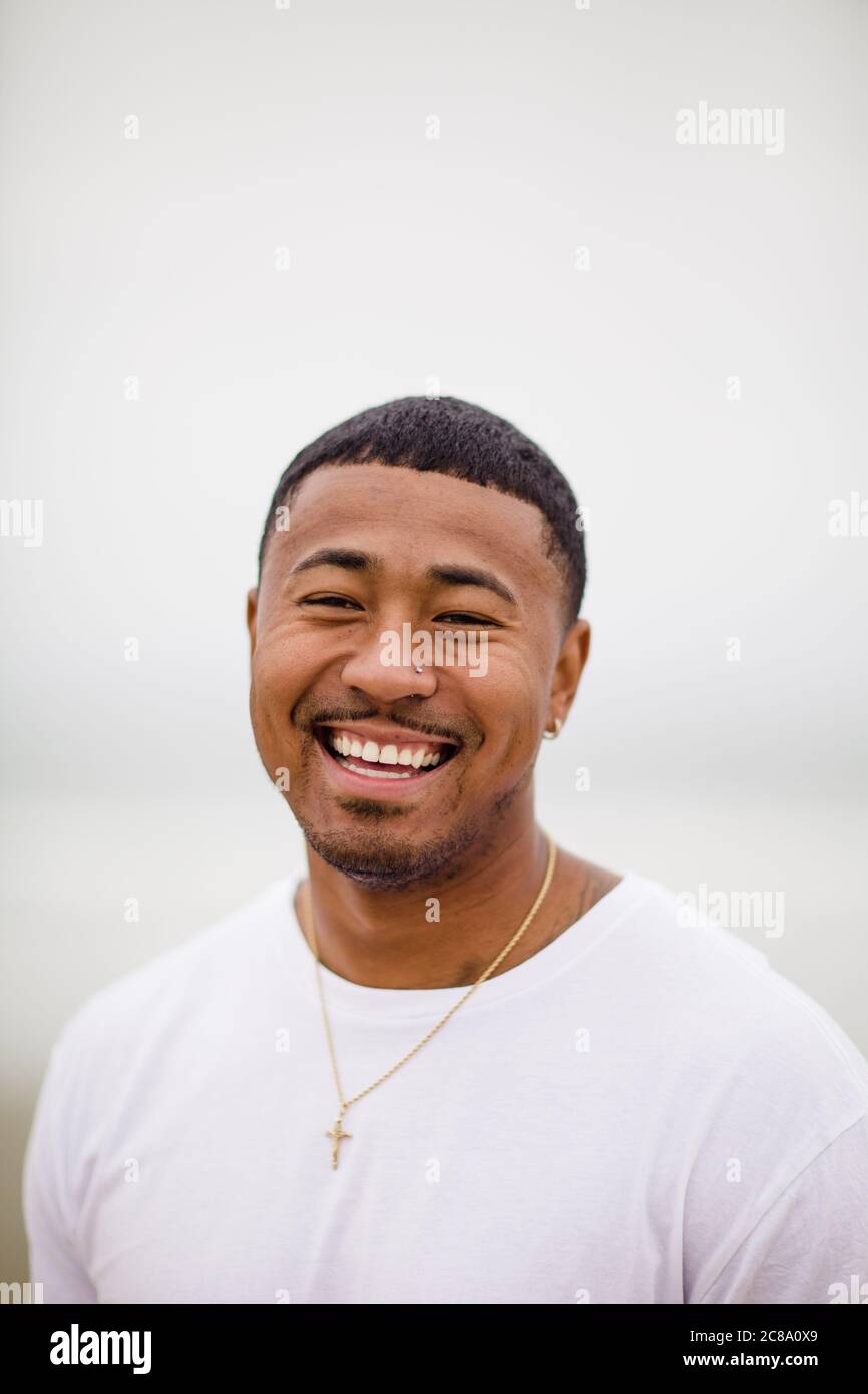 Mixed Race Man Smiling at Beach Stock Photo - Alamy