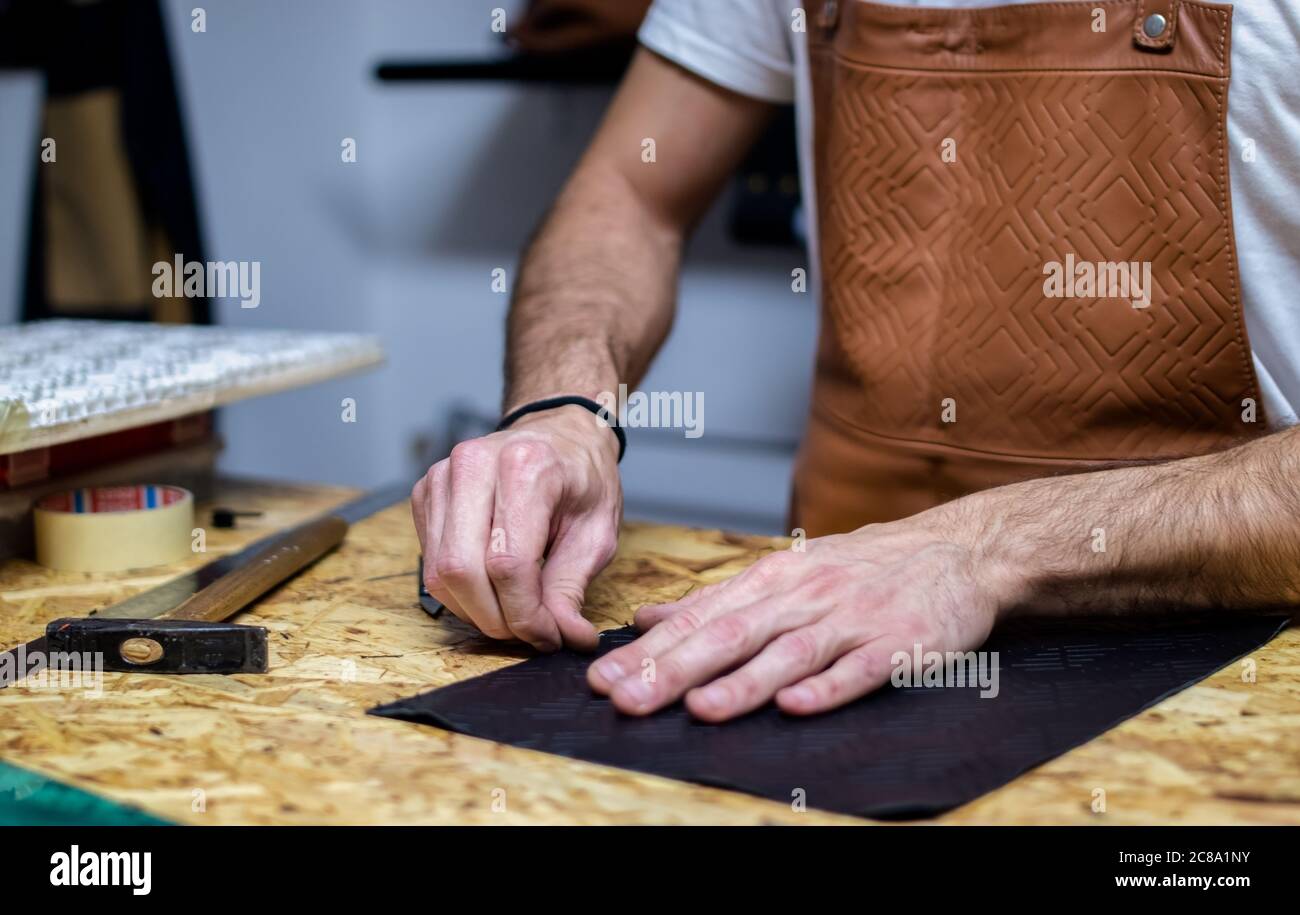 craftsman working with hands and hammer on leather in laboratory Stock ...
