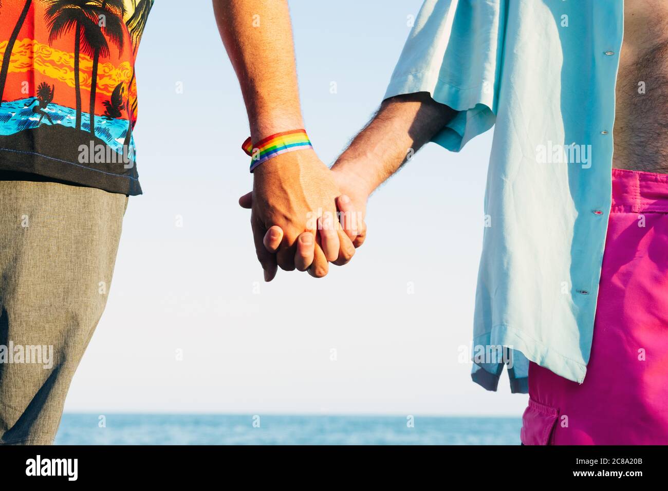 Two men in love holding hands on the beach stock photo Stock Photo - Alamy
