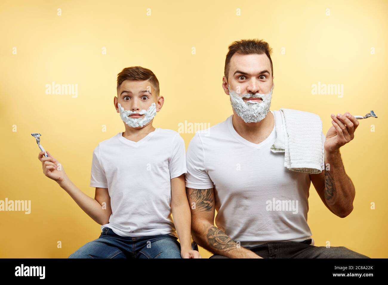 bearded Father and son shaving on yellow background Stock Photo - Alamy