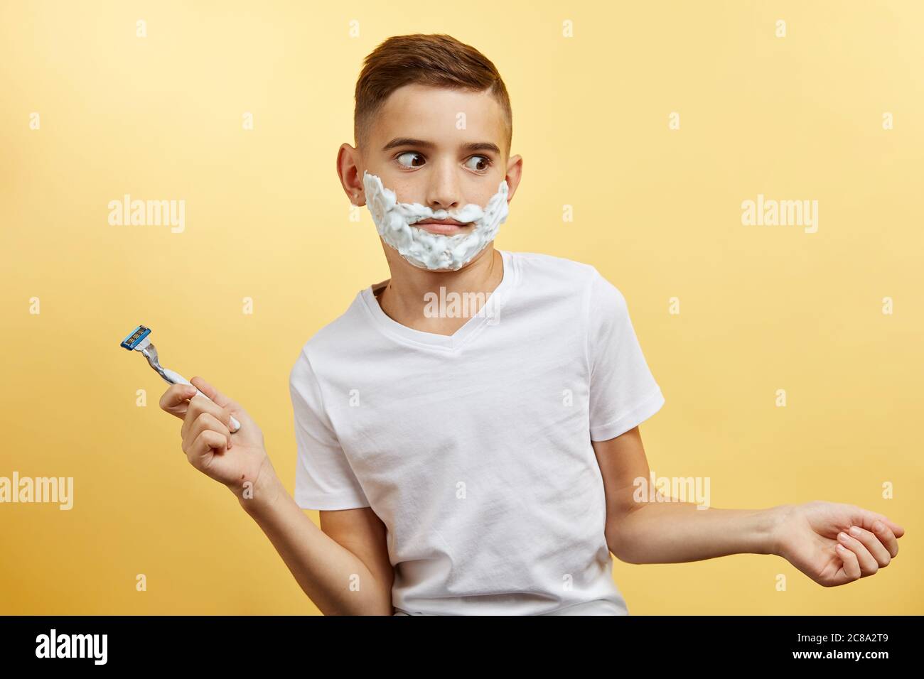 shoking boy do not know how shaving with razor blade in his hand, on ...