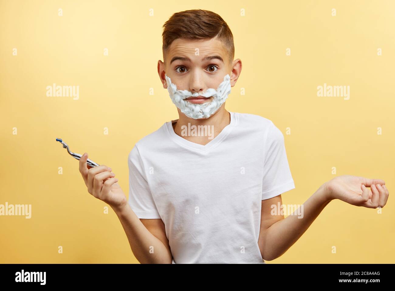 shoking boy do not know how shaving with razor blade in his hand, on ...