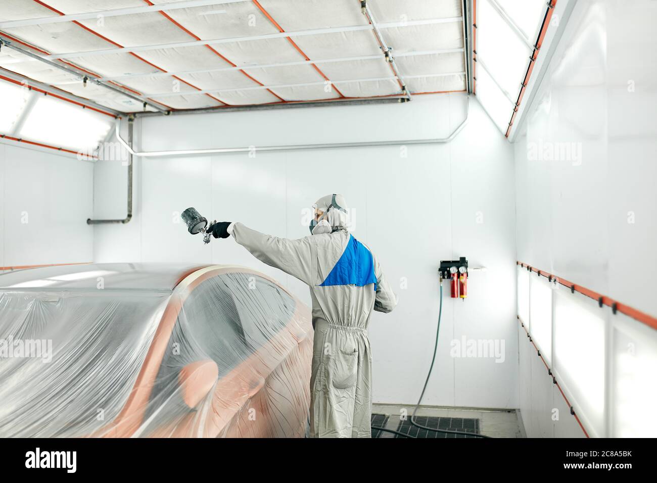 repairman painter in chamber painting automobile car roof Stock Photo ...