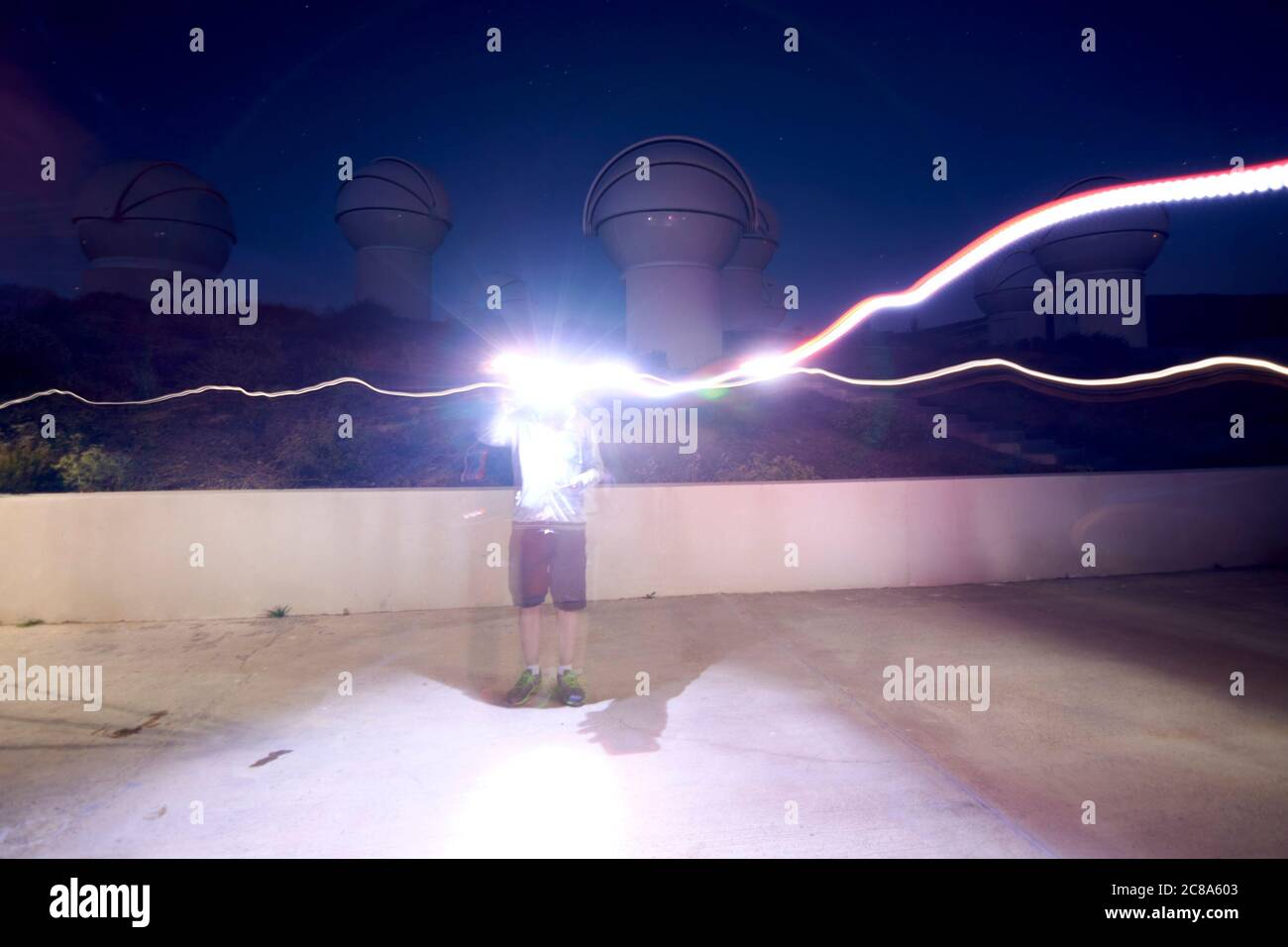 Person with light bulb on the head, light rays, night photography Stock ...