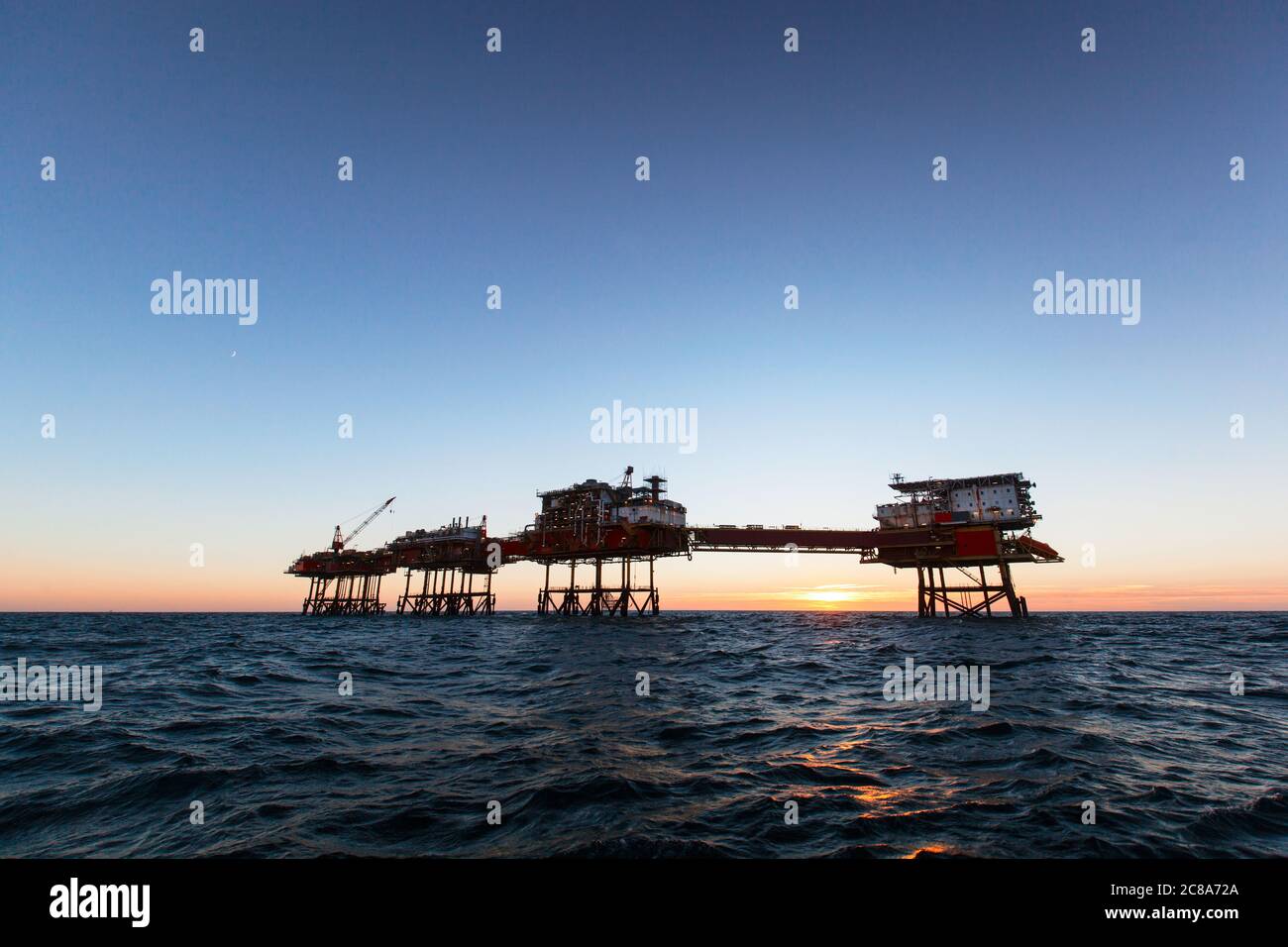 Offshore oil platform at sunset time Stock Photo - Alamy