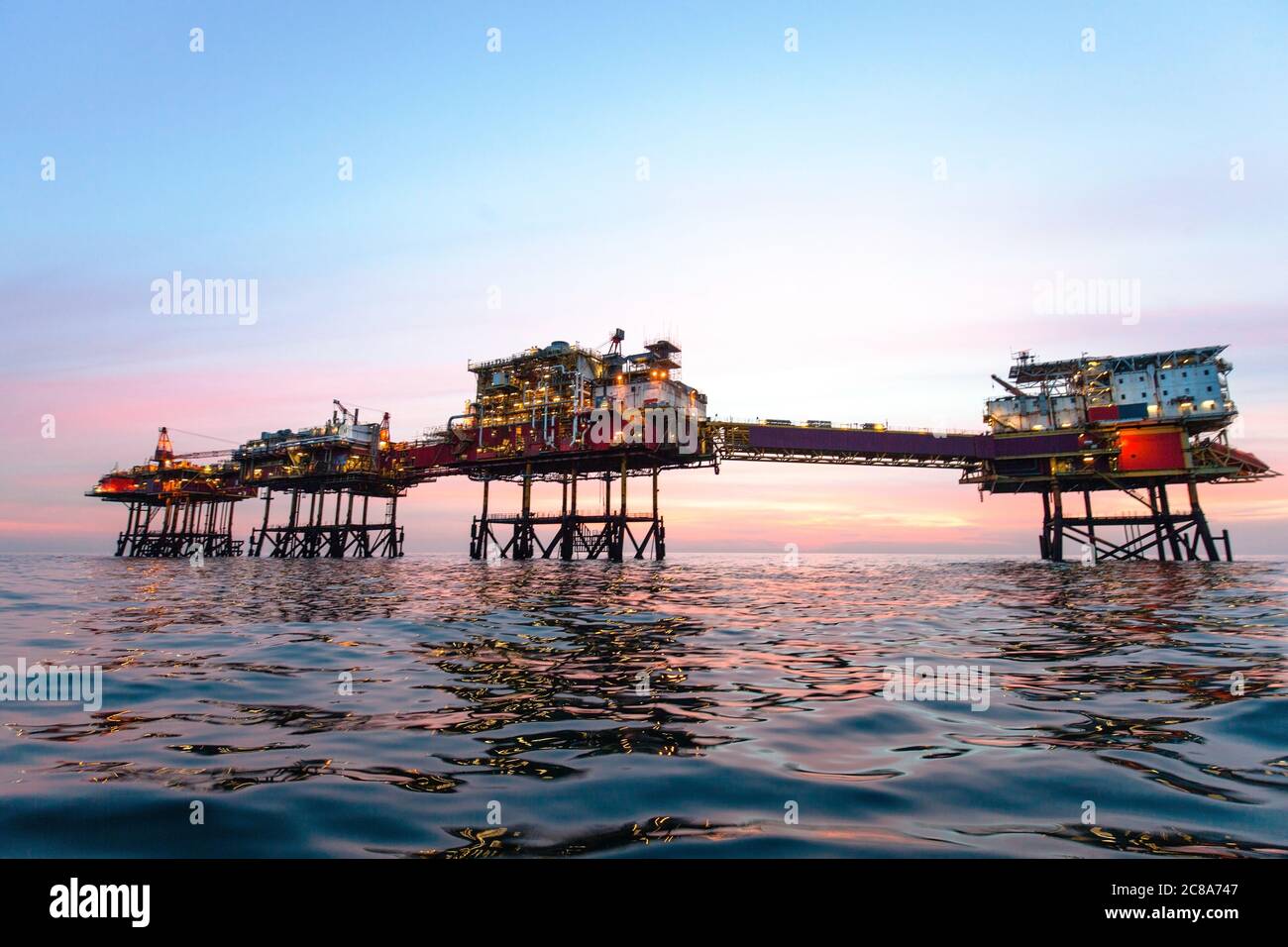 Offshore oil platform at sunset time Stock Photo - Alamy