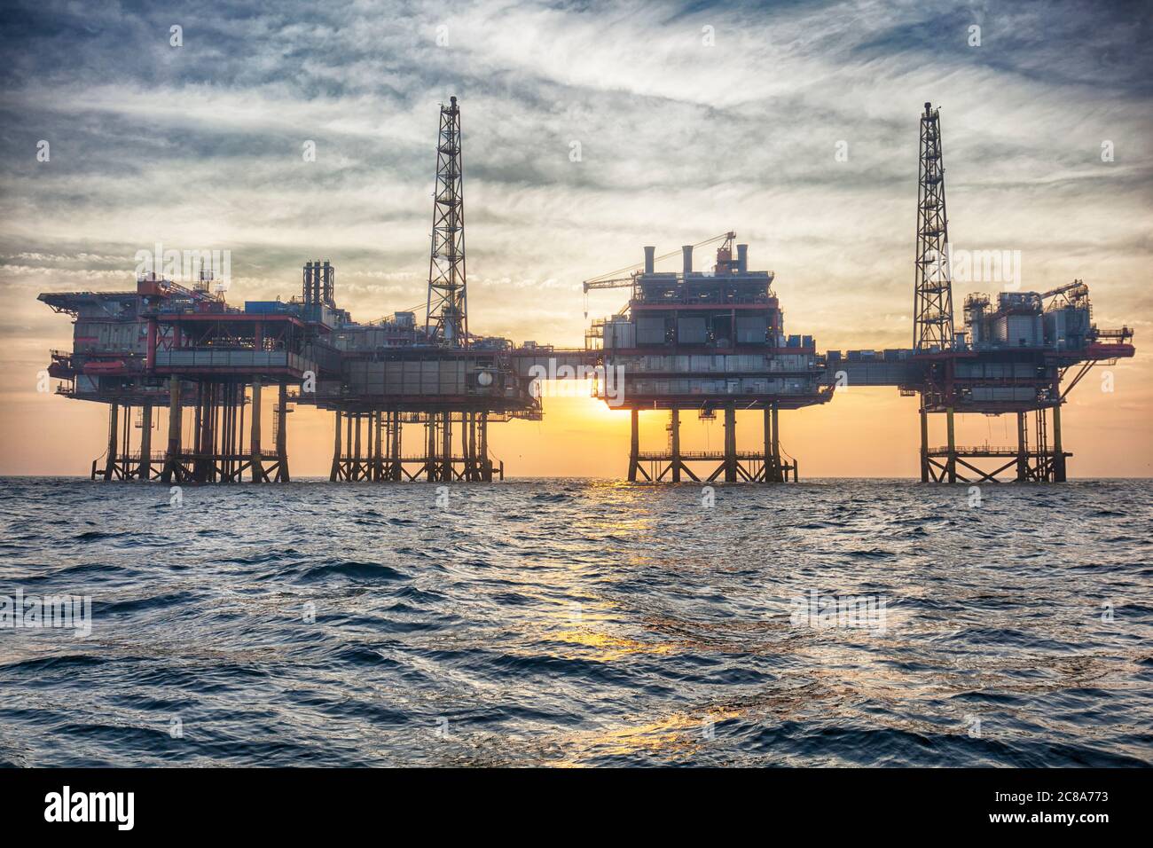 Offshore oil platform at sunset time Stock Photo - Alamy