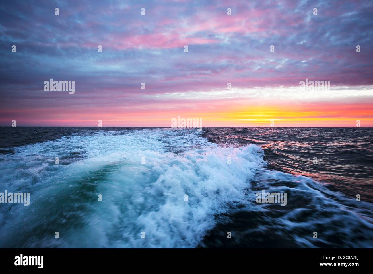 Boats wake during sunset time Stock Photo - Alamy