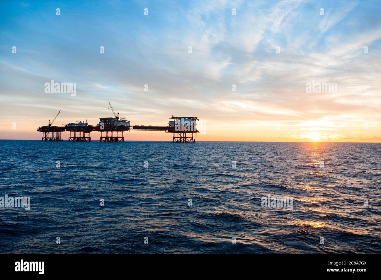 Offshore oil platform at sunset time Stock Photo - Alamy