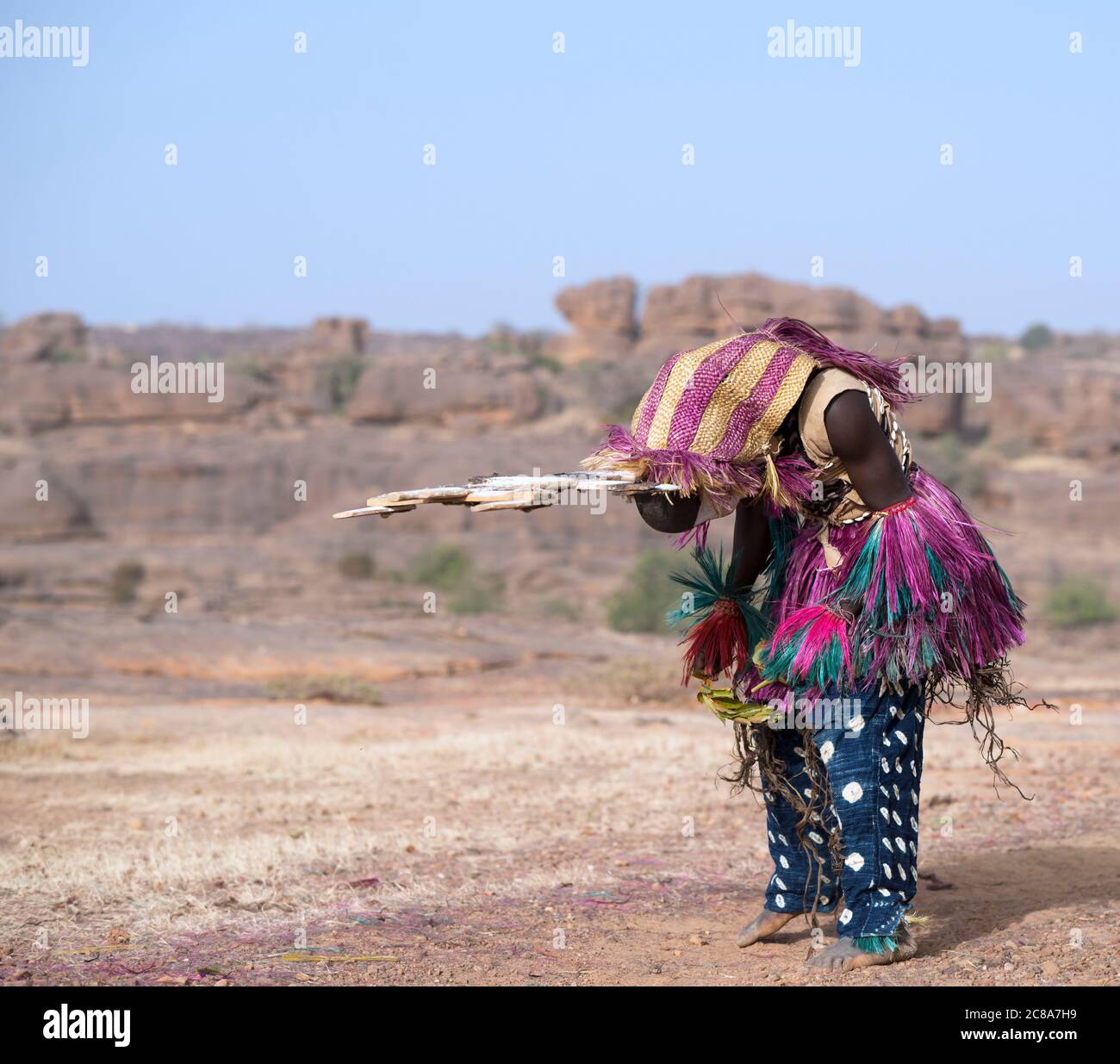 A group of Dogon men performing a ritual tribal masked dance ceremony ...