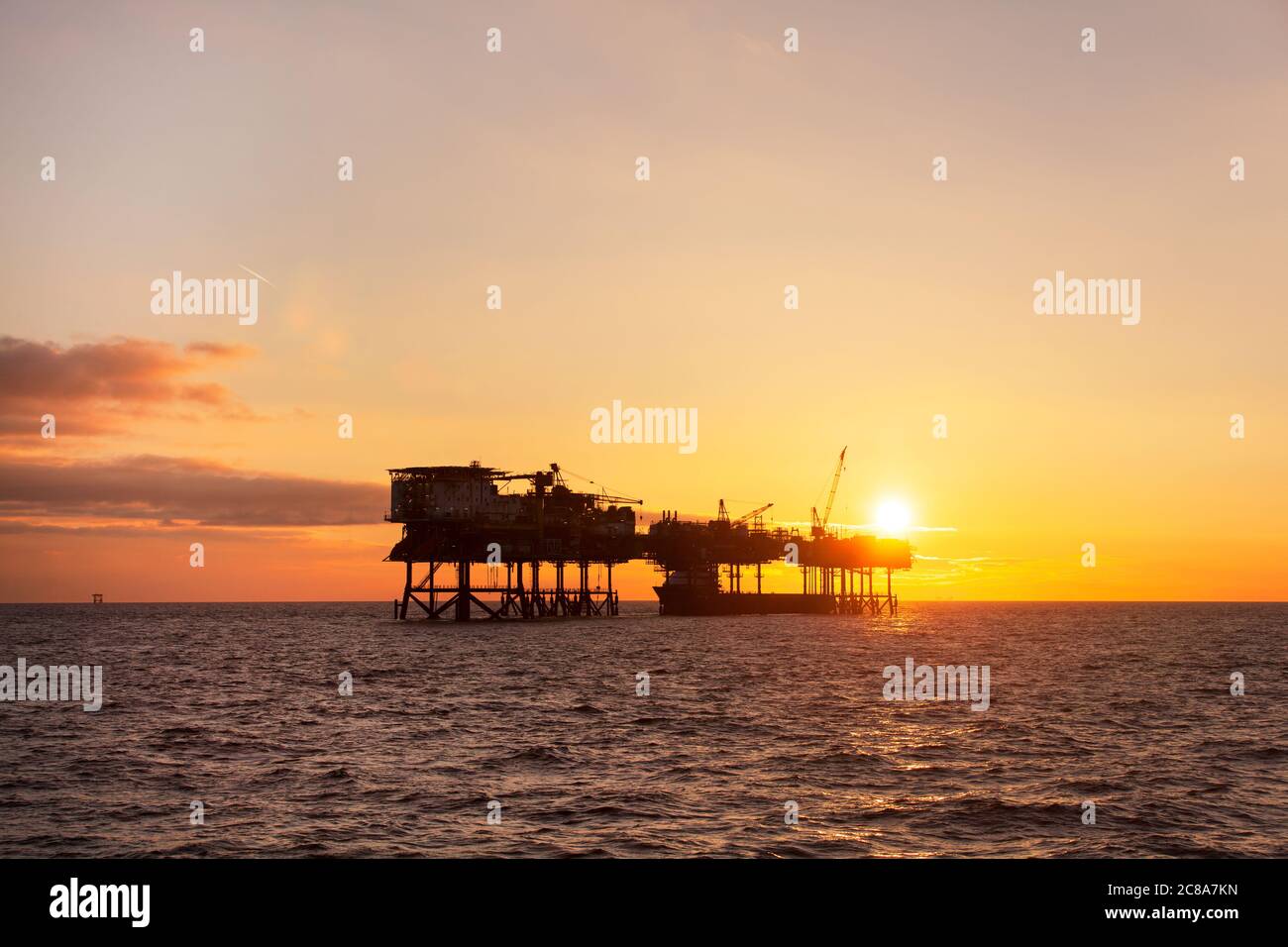 Offshore oil platform at sunset time Stock Photo - Alamy