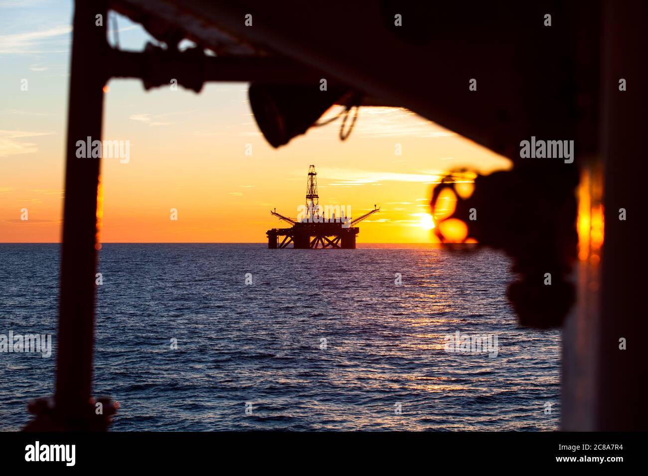 OIl rig at sunnset time Stock Photo - Alamy