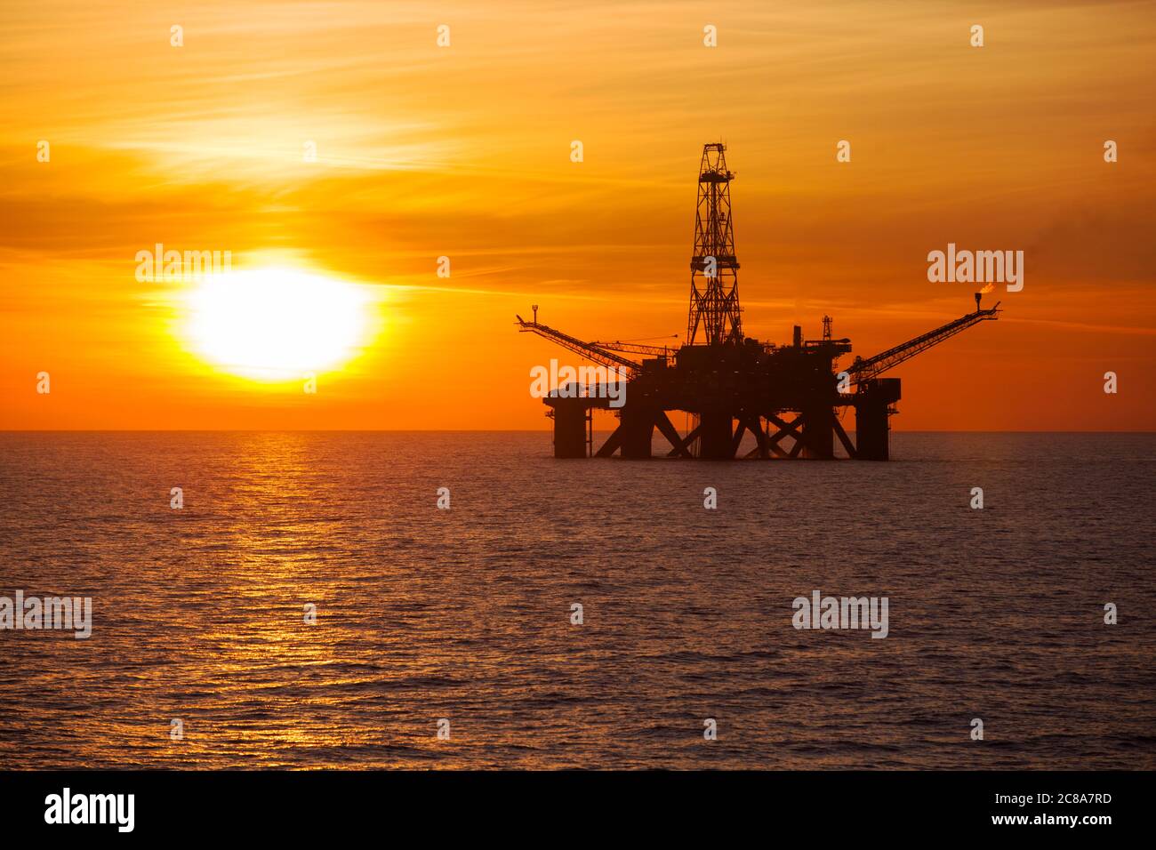 OIl rig at sunnset time Stock Photo - Alamy