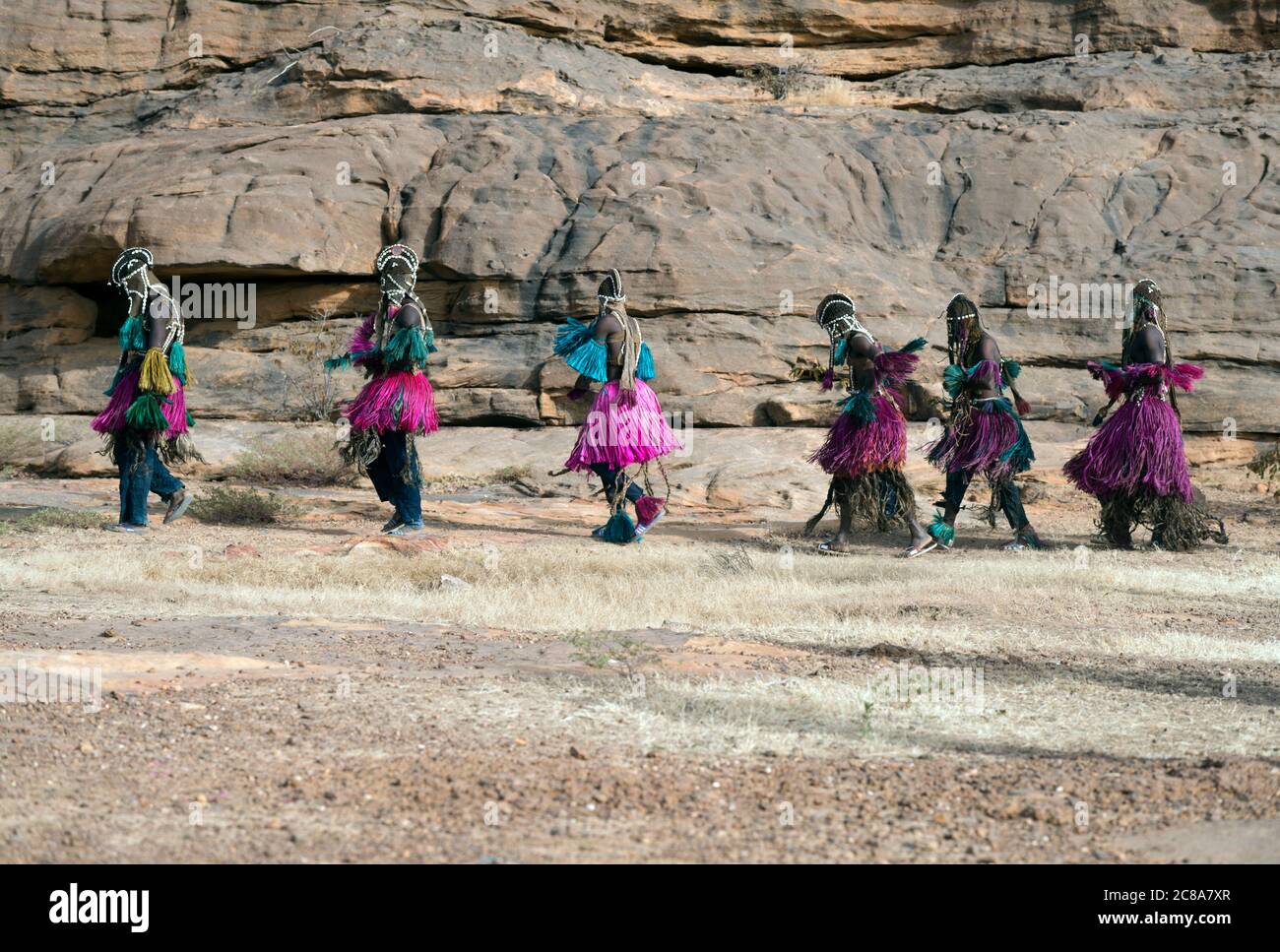 A group of Dogon men performing a ritual tribal masked dance ceremony ...