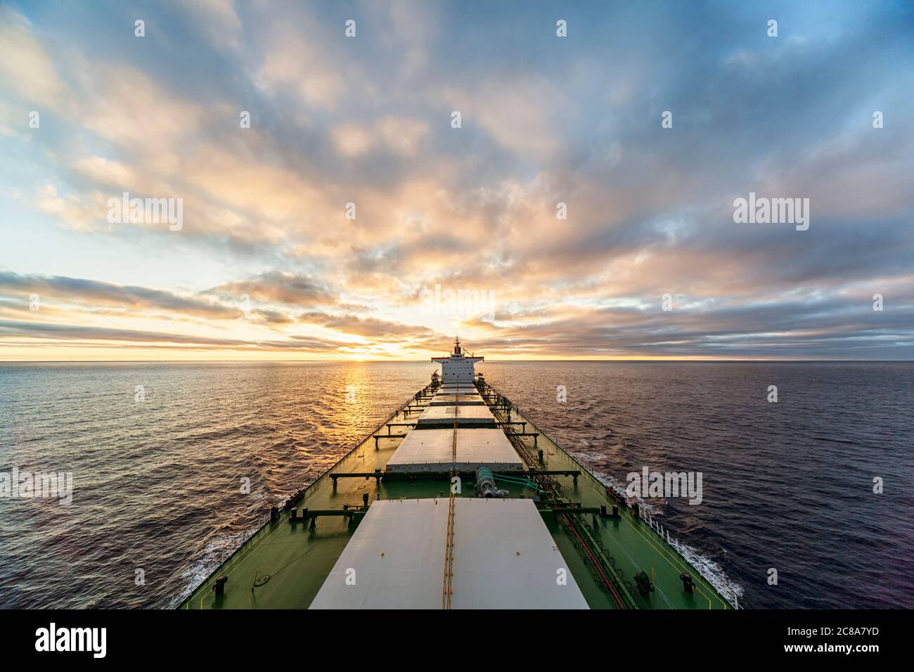 Ship underway at sunset time Stock Photo - Alamy