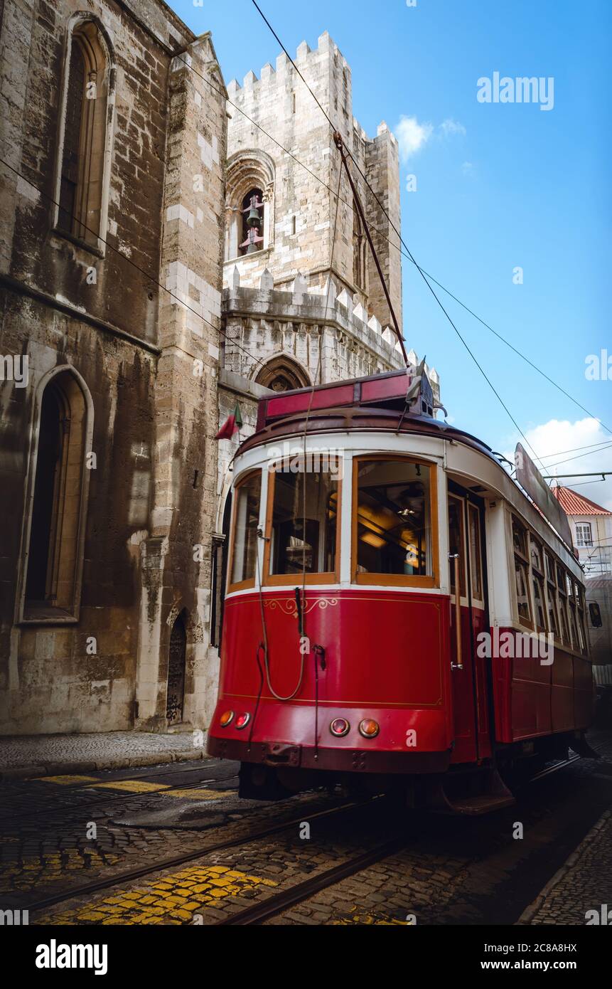 Traditional old red tramcar cable electric trolley running over the ...