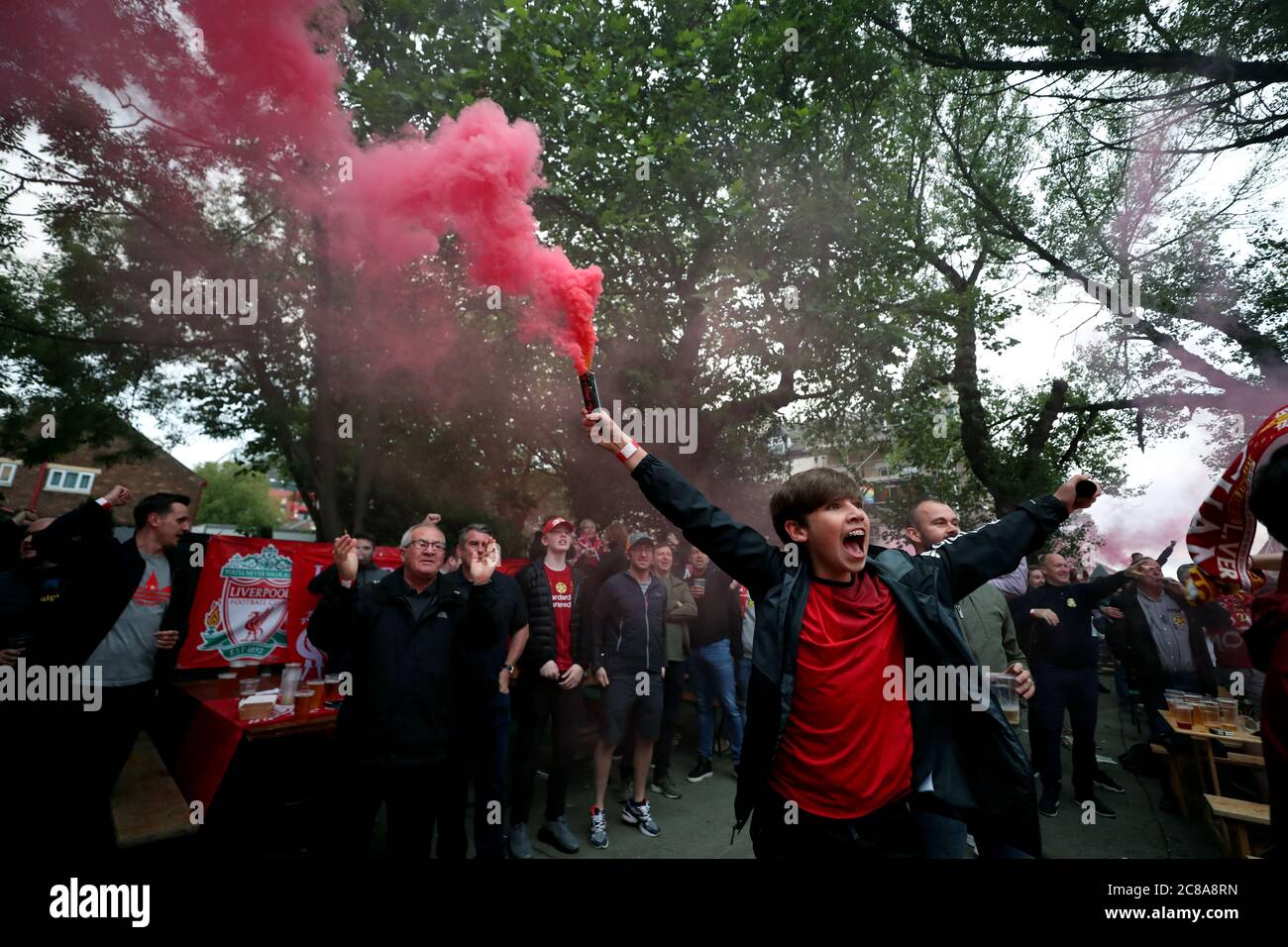 Liverpool fans with flares celebrate their sides second goal during ...