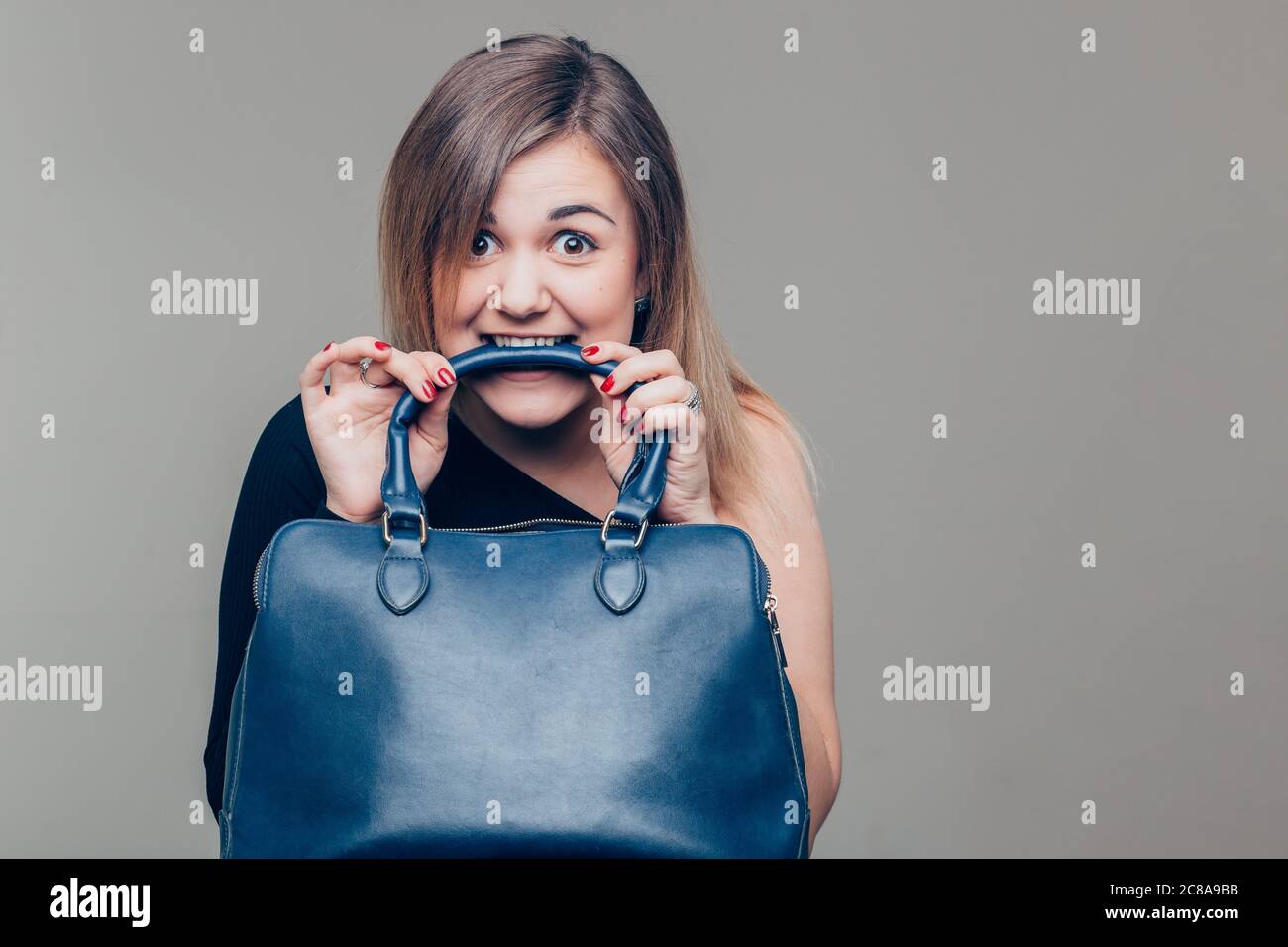 Woman choosing leather bag hi-res stock photography and images - Alamy