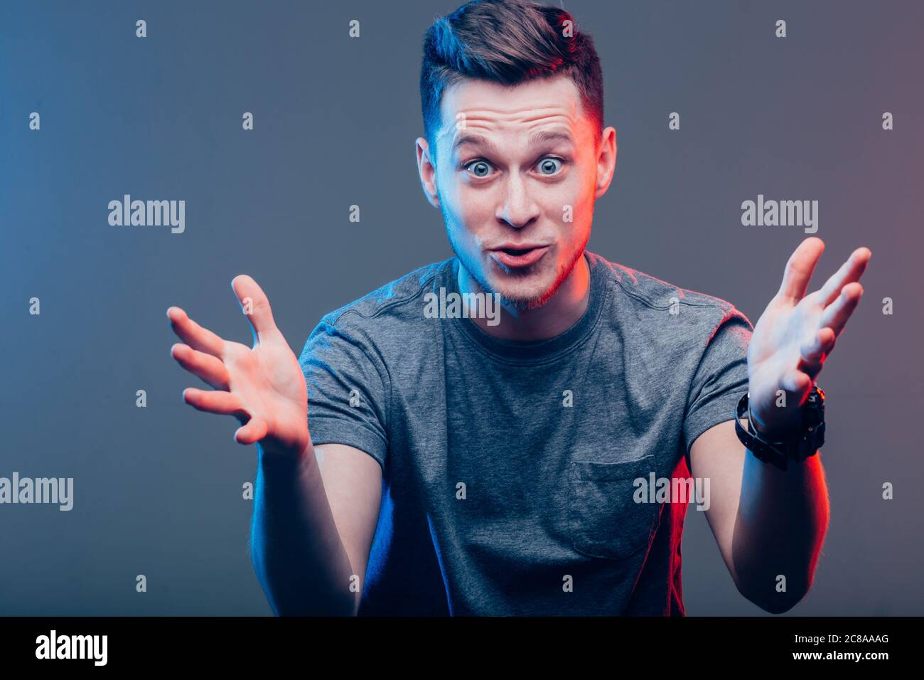 Portrait of young man with shocked facial expression Stock Photo - Alamy