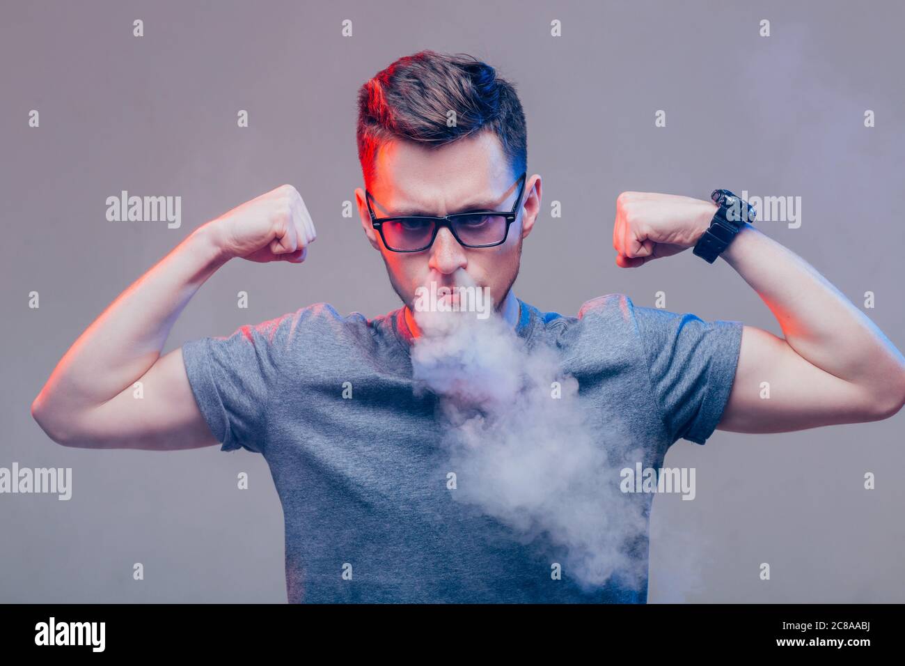 Men with beard in sunglasses vaping and releases a cloud of vapor in ...