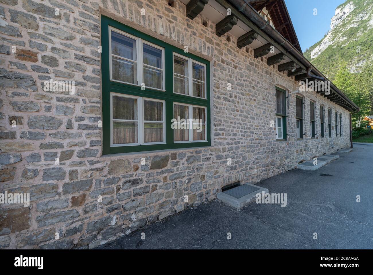 Series of windows lined up on a building of clear stones, mountain ...