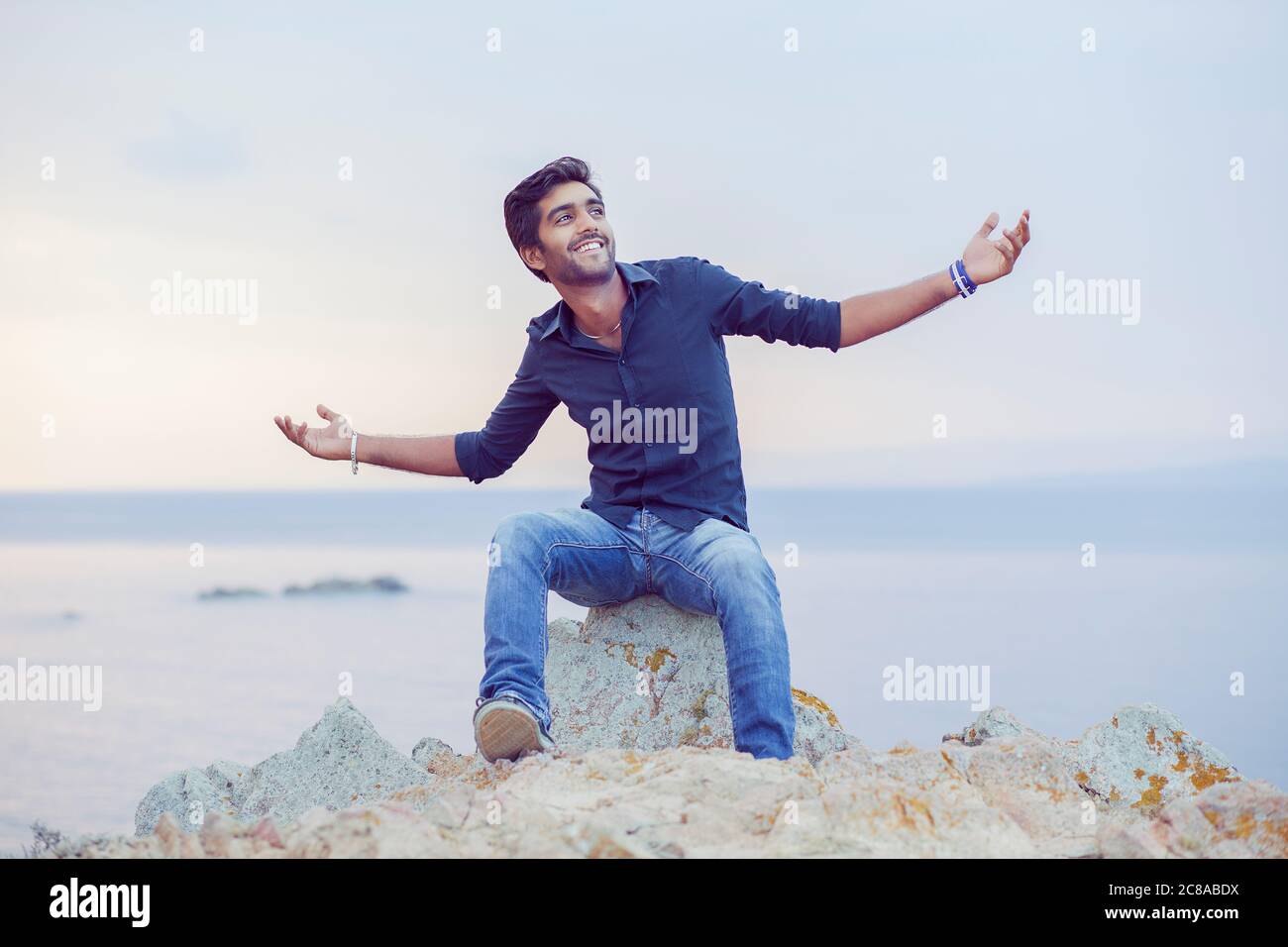 Man smiling looking up to blue sky taking deep breath celebrating ...