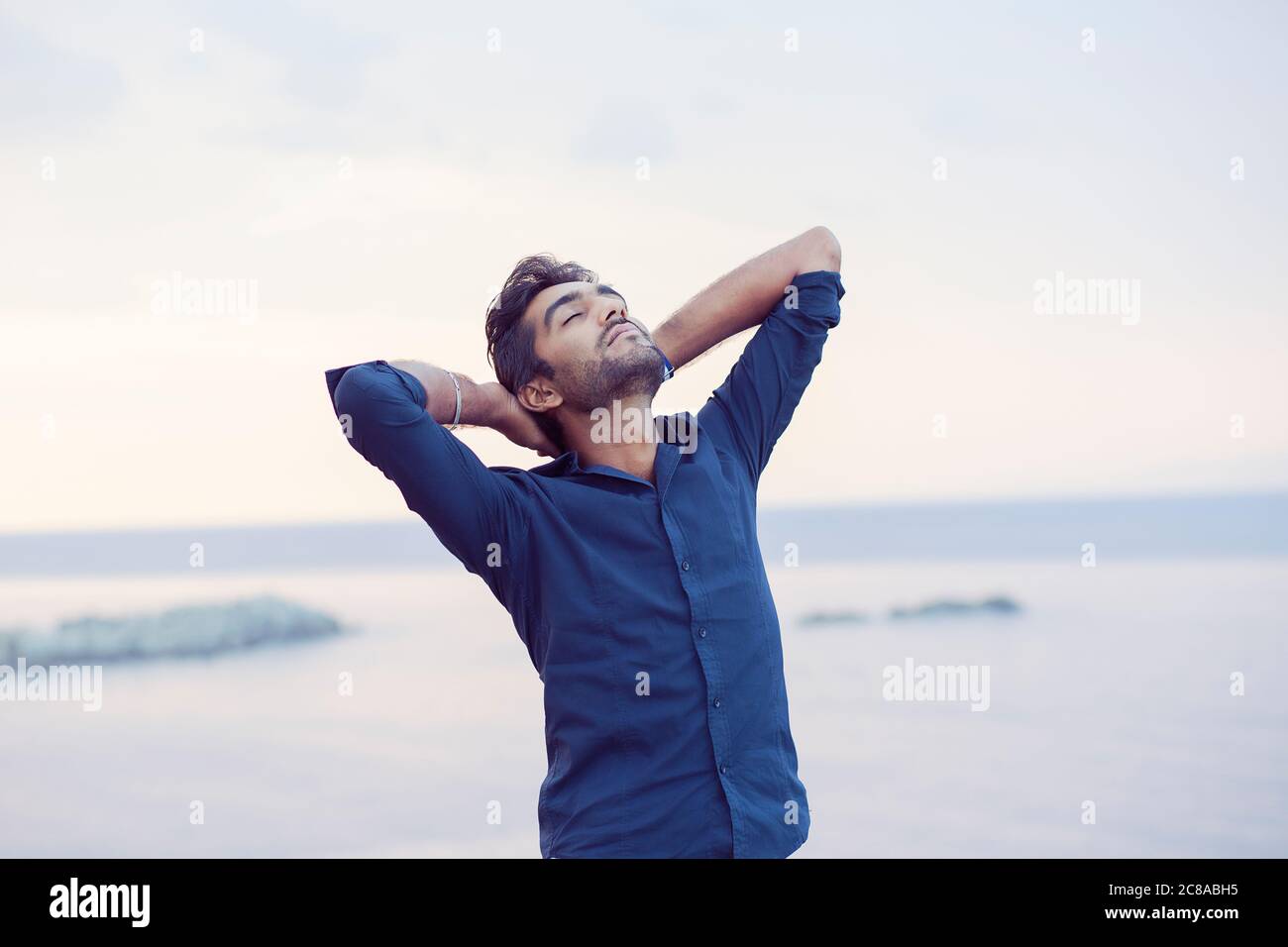 Man smiling looking up to blue sky taking deep breath celebrating ...