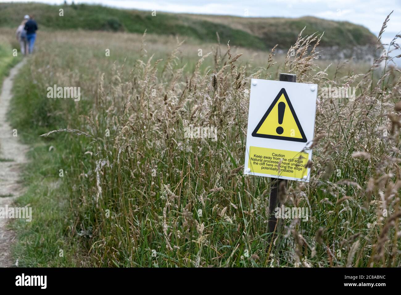 Warning sign on the footpath at Bempton cliffs warning of unstable ...