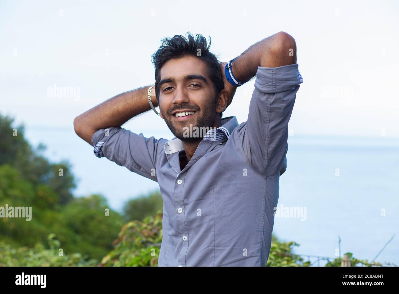 Man smiling looking up to blue sky taking deep breath celebrating ...