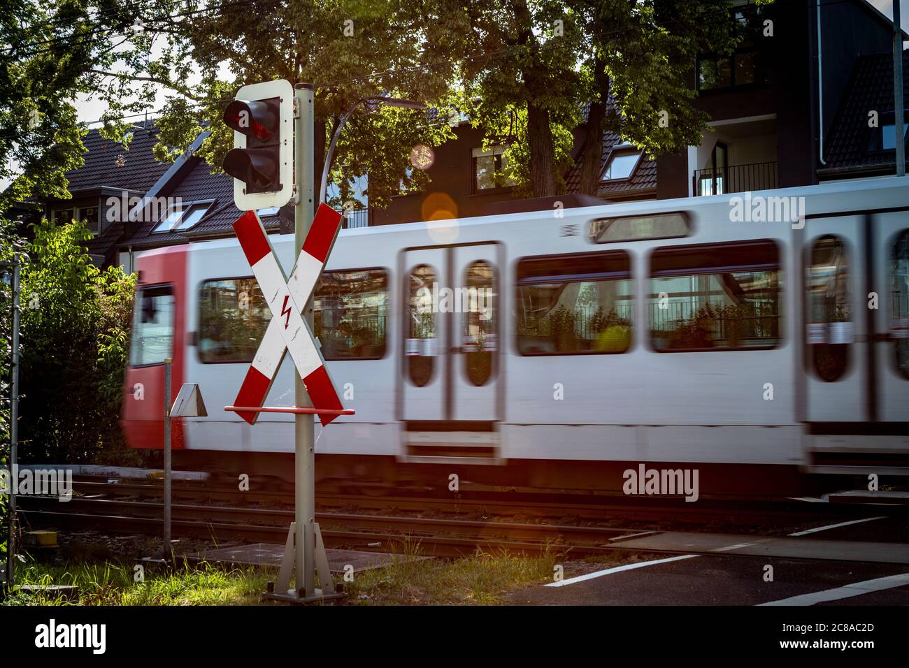 Cologne tram at a street crossing, traffic light is on red, outdoors ...