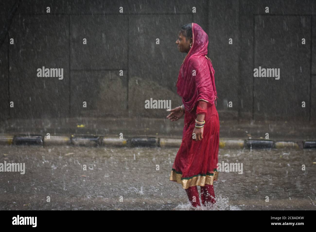 A woman seen drenched in wet during the heavy rainfall in Delhi.Heavy ...