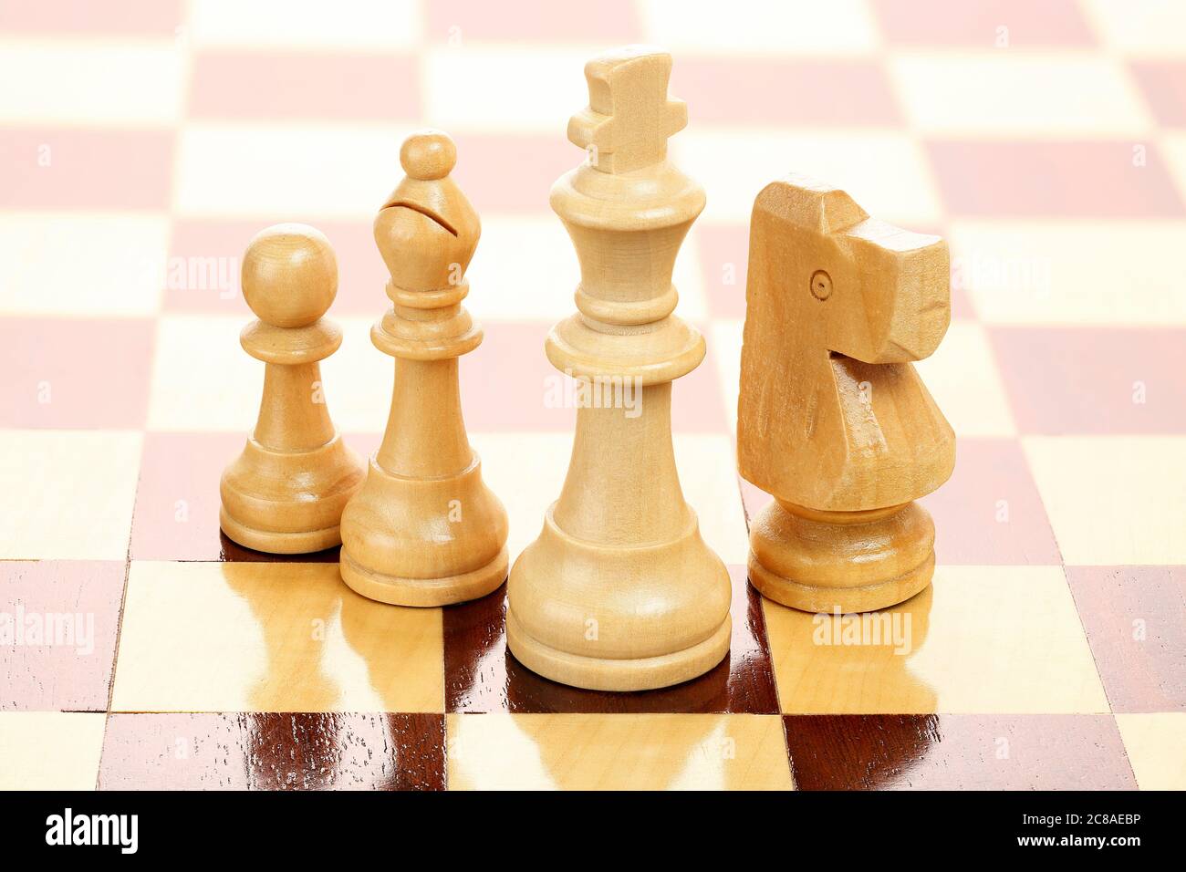 wooden king, knight, bishop and pawn on chessboard Stock Photo - Alamy