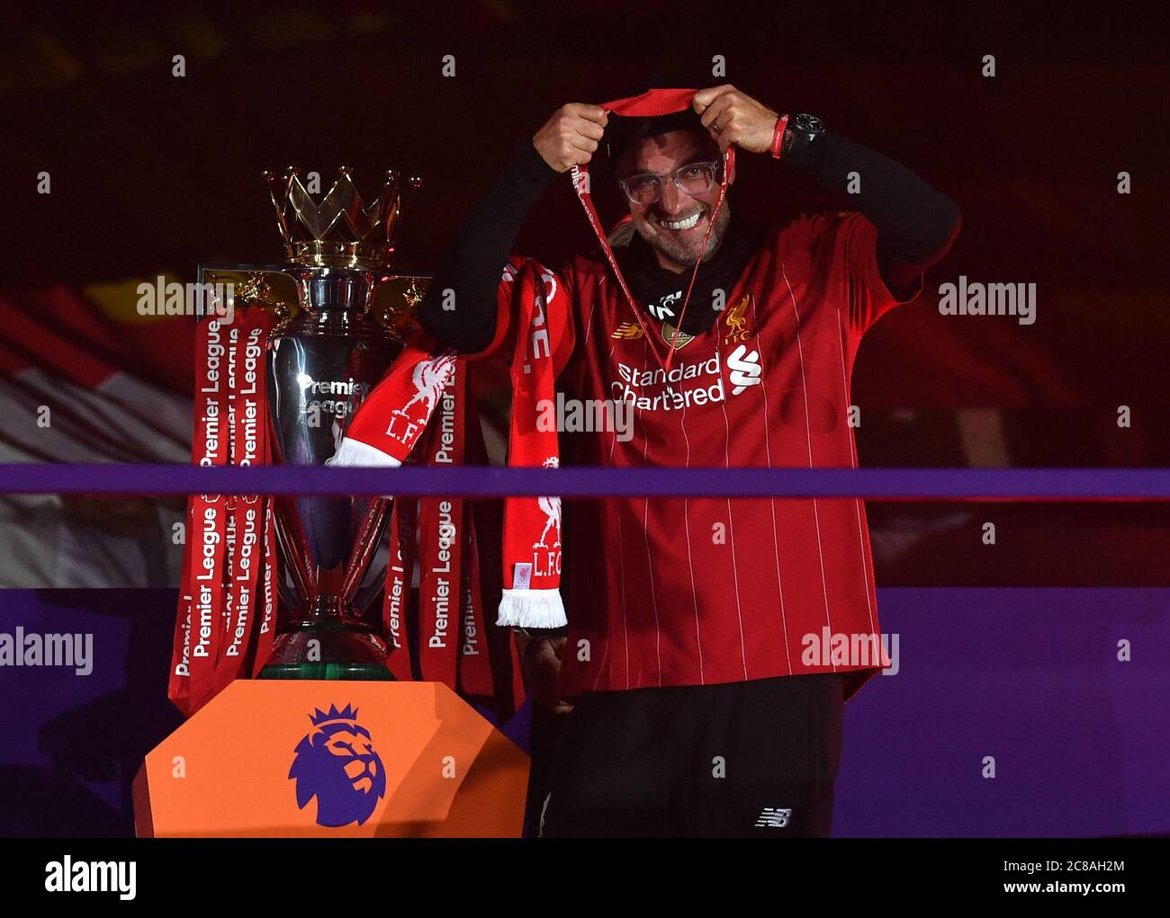 Liverpool manager Jurgen Klopp beside the Premier League Trophy prior ...