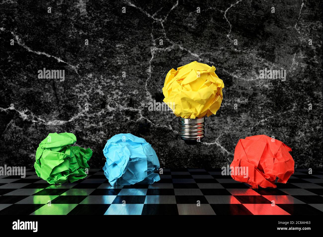 crumpled paper light bulb above other crumpled paper balls, idea or ...