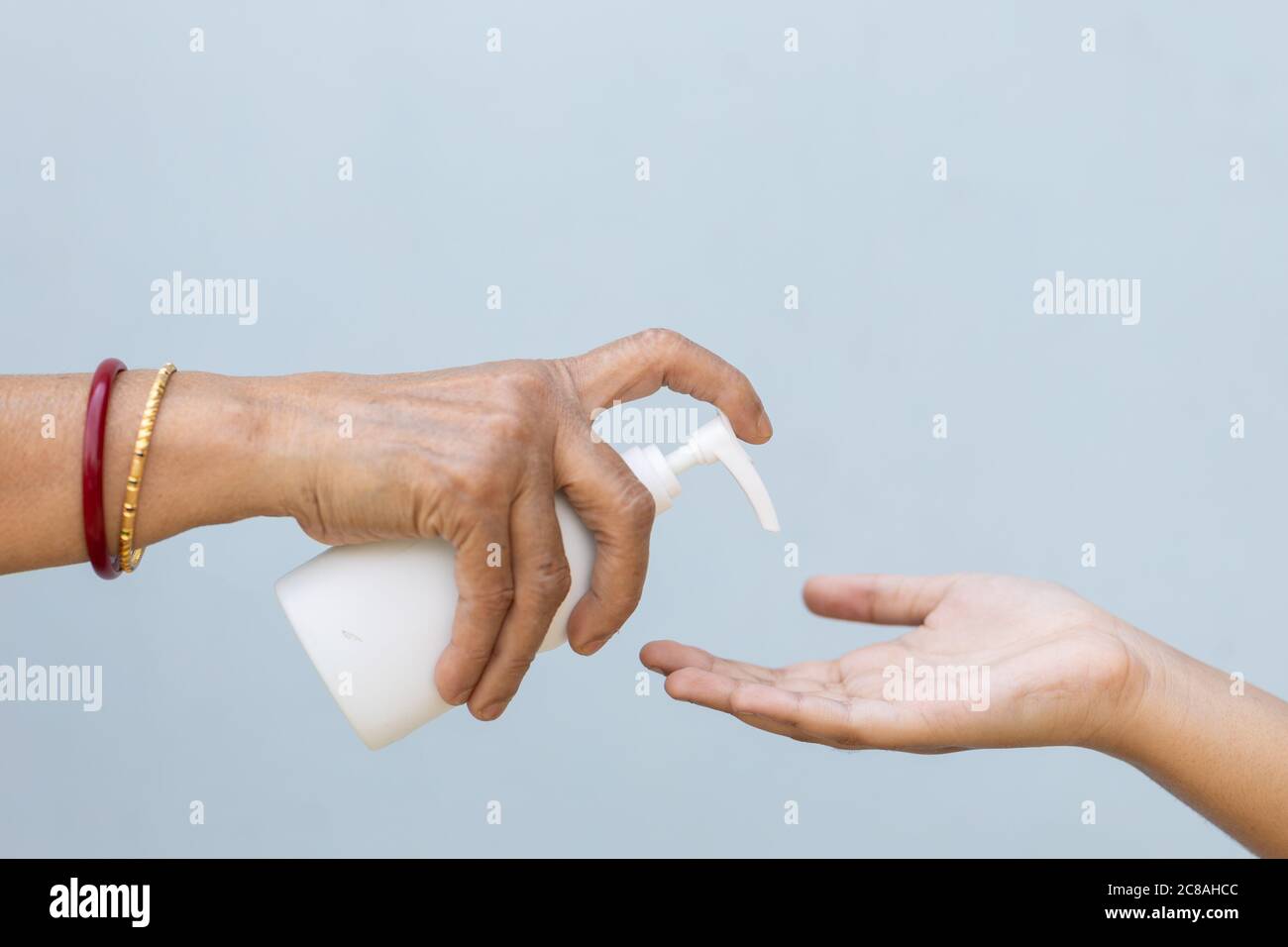 Hand pouring water into another hand hi-res stock photography and ...